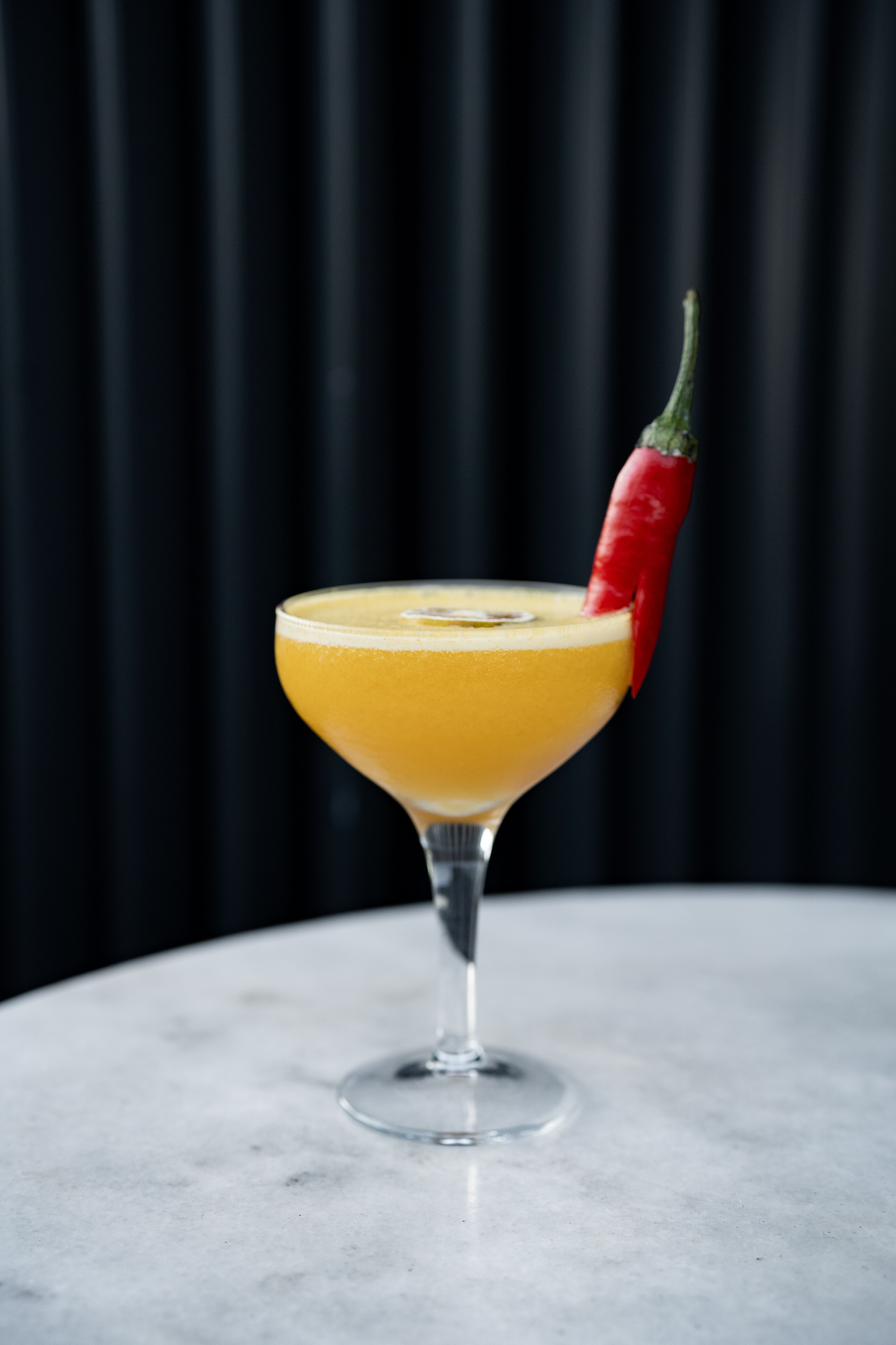 A cocktail with a chili pepper on top · Free Stock Photo