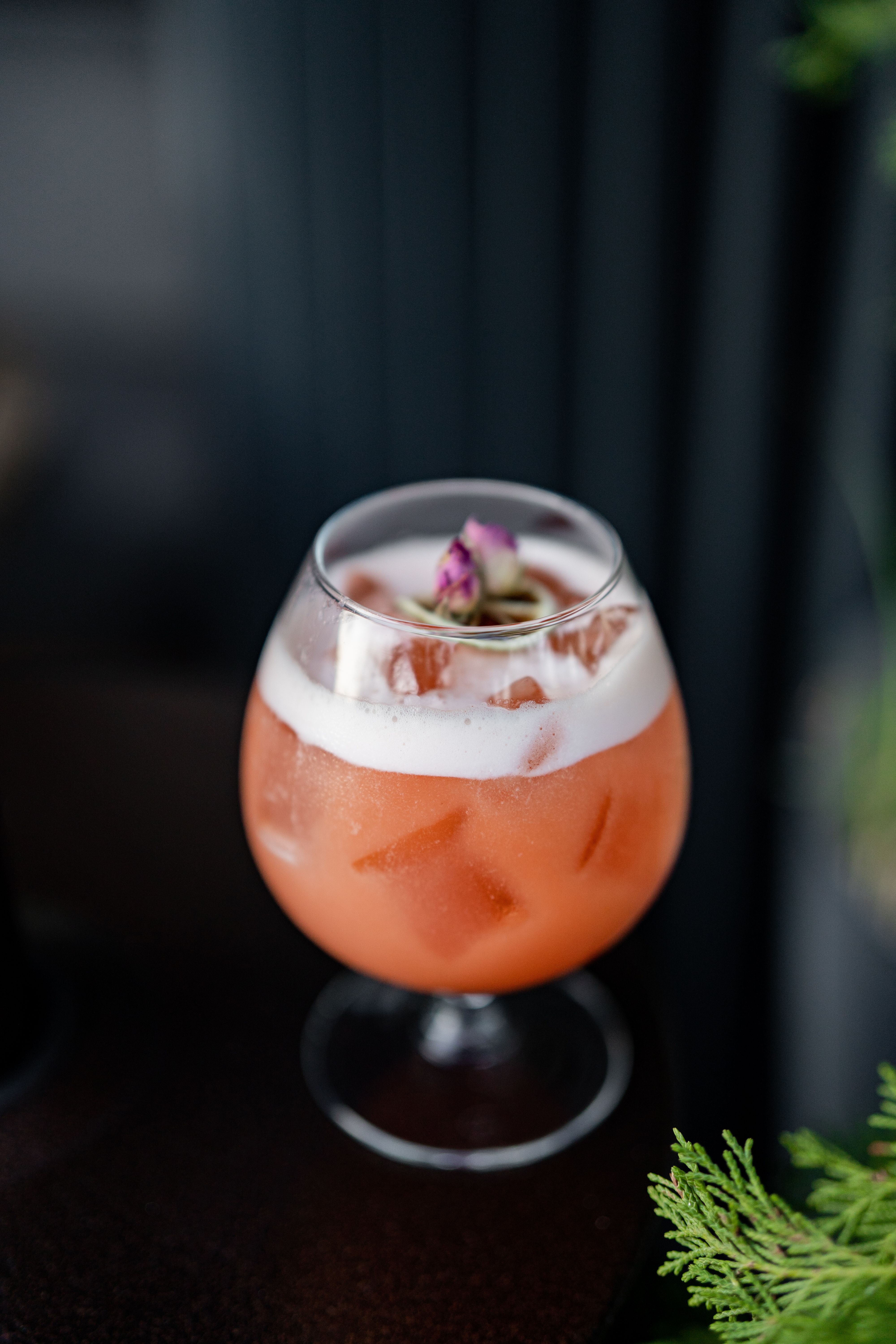 A cocktail with pink drink and garnish on a table · Free Stock Photo