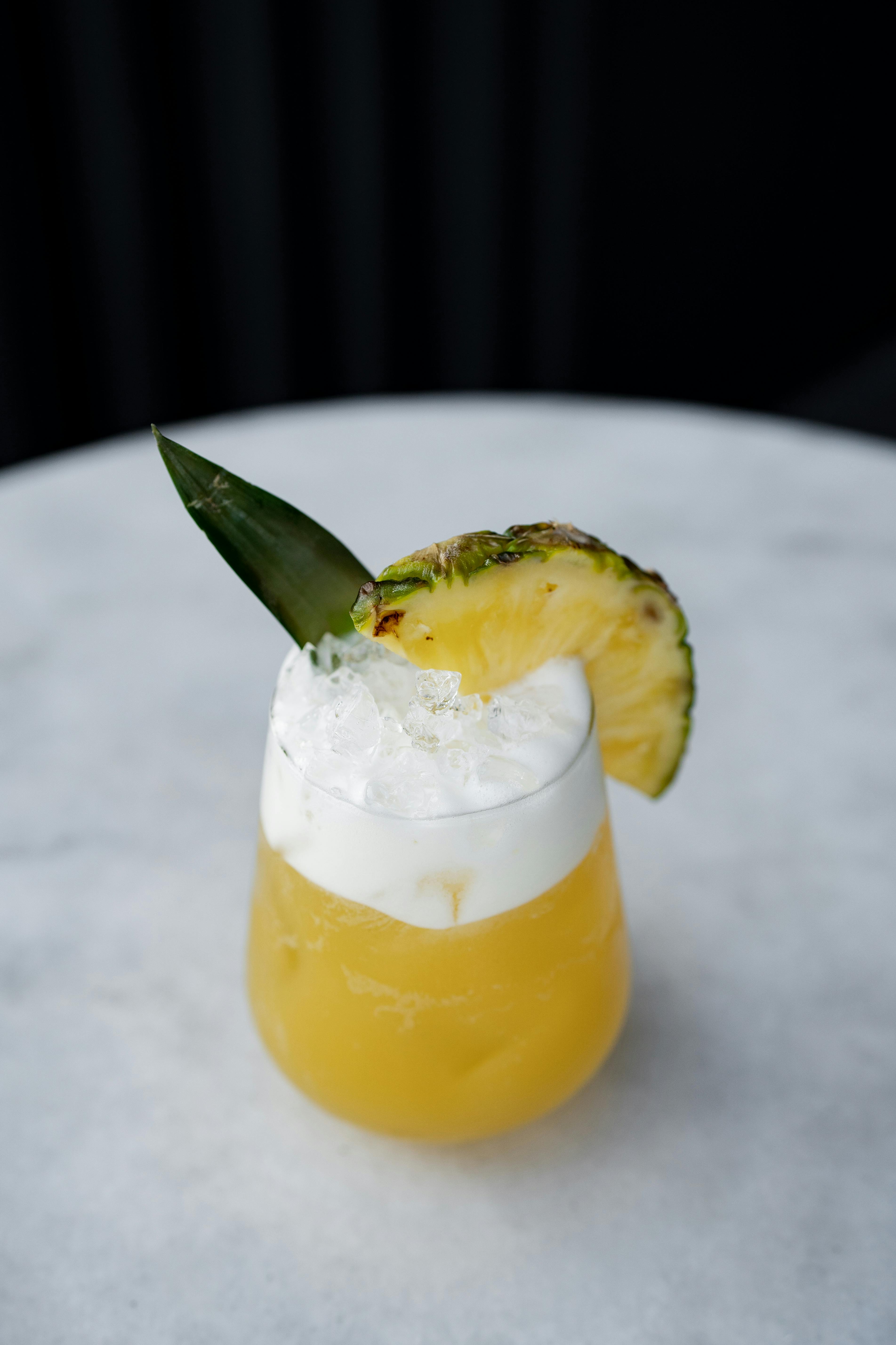 A cocktail with a pineapple garnish on top · Free Stock Photo