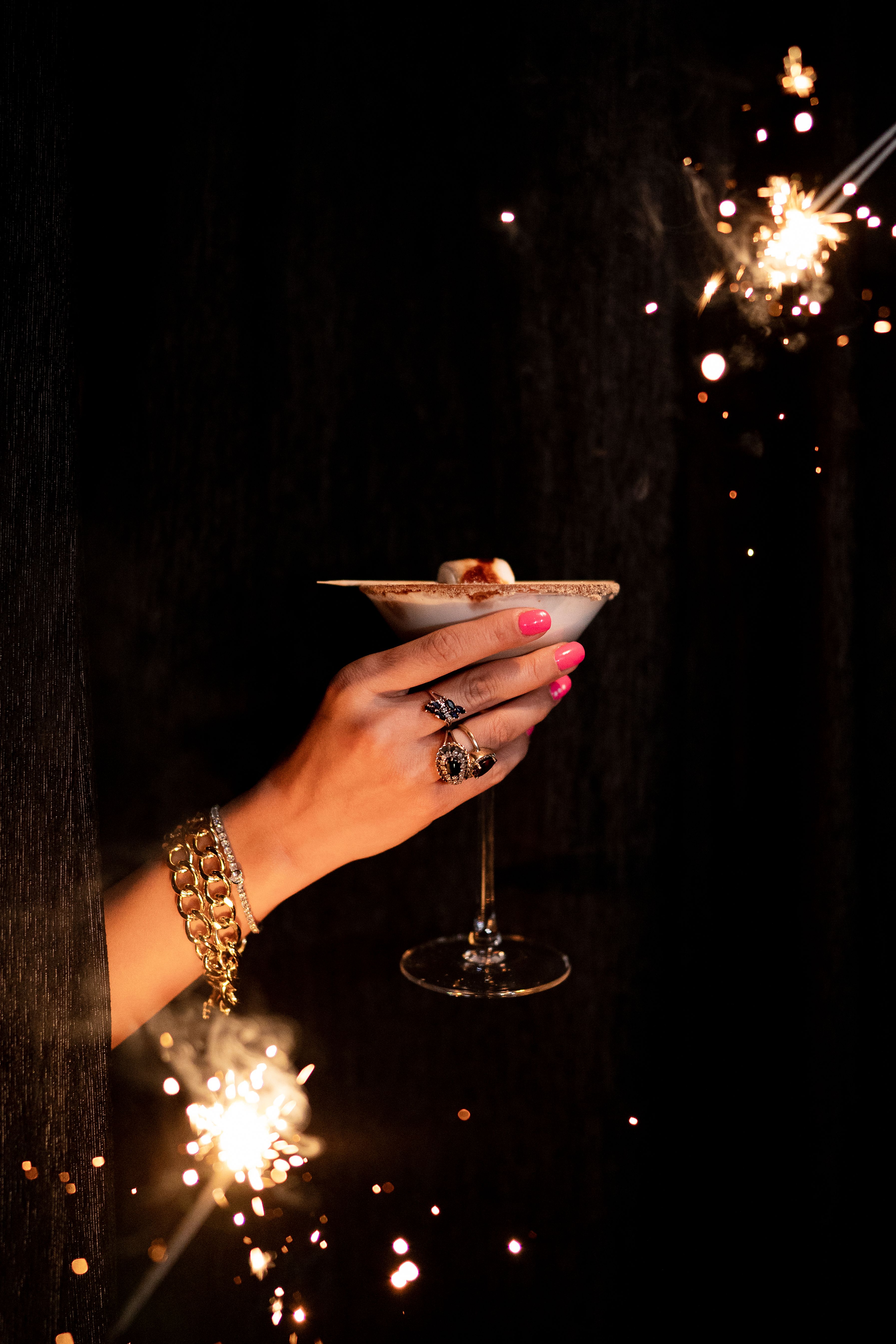 Woman Holding Drink Among Sparkles · Free Stock Photo