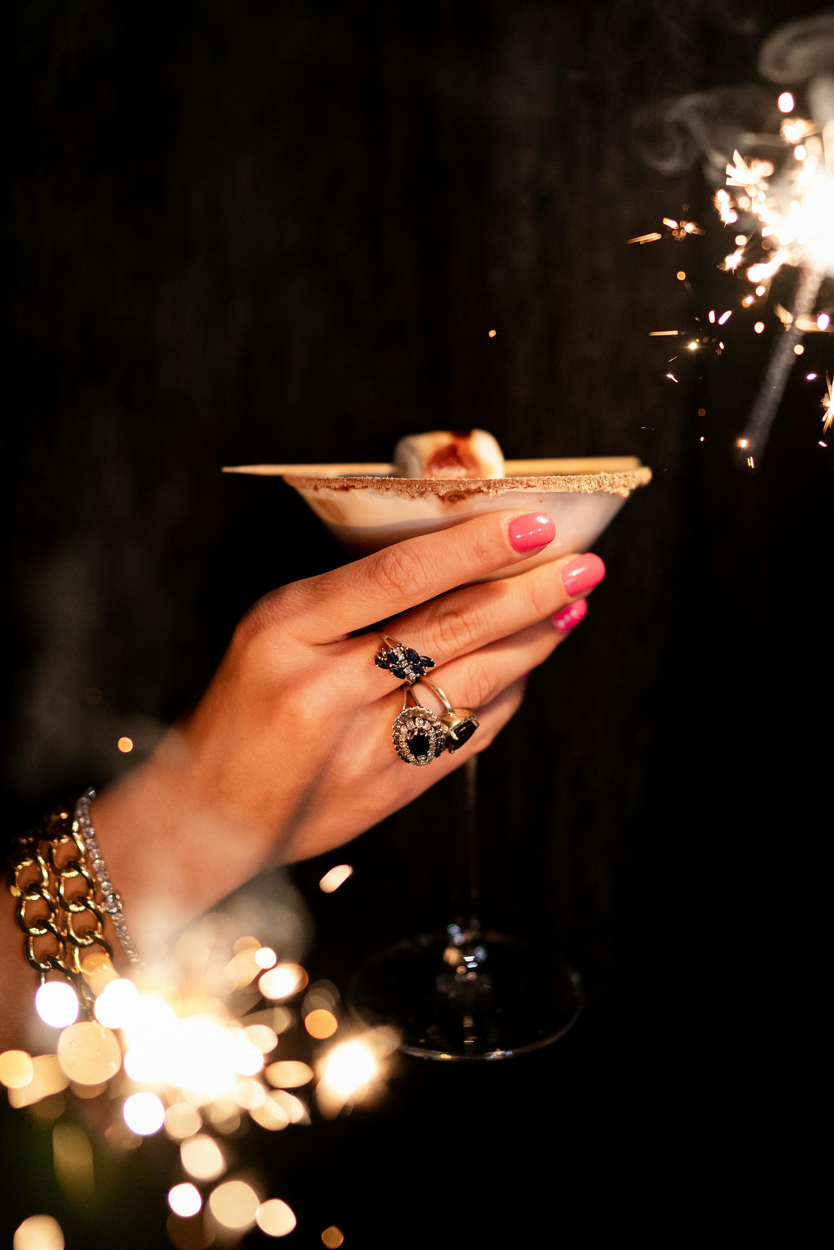 Sparklers around Hand with Cocktail · Free Stock Photo