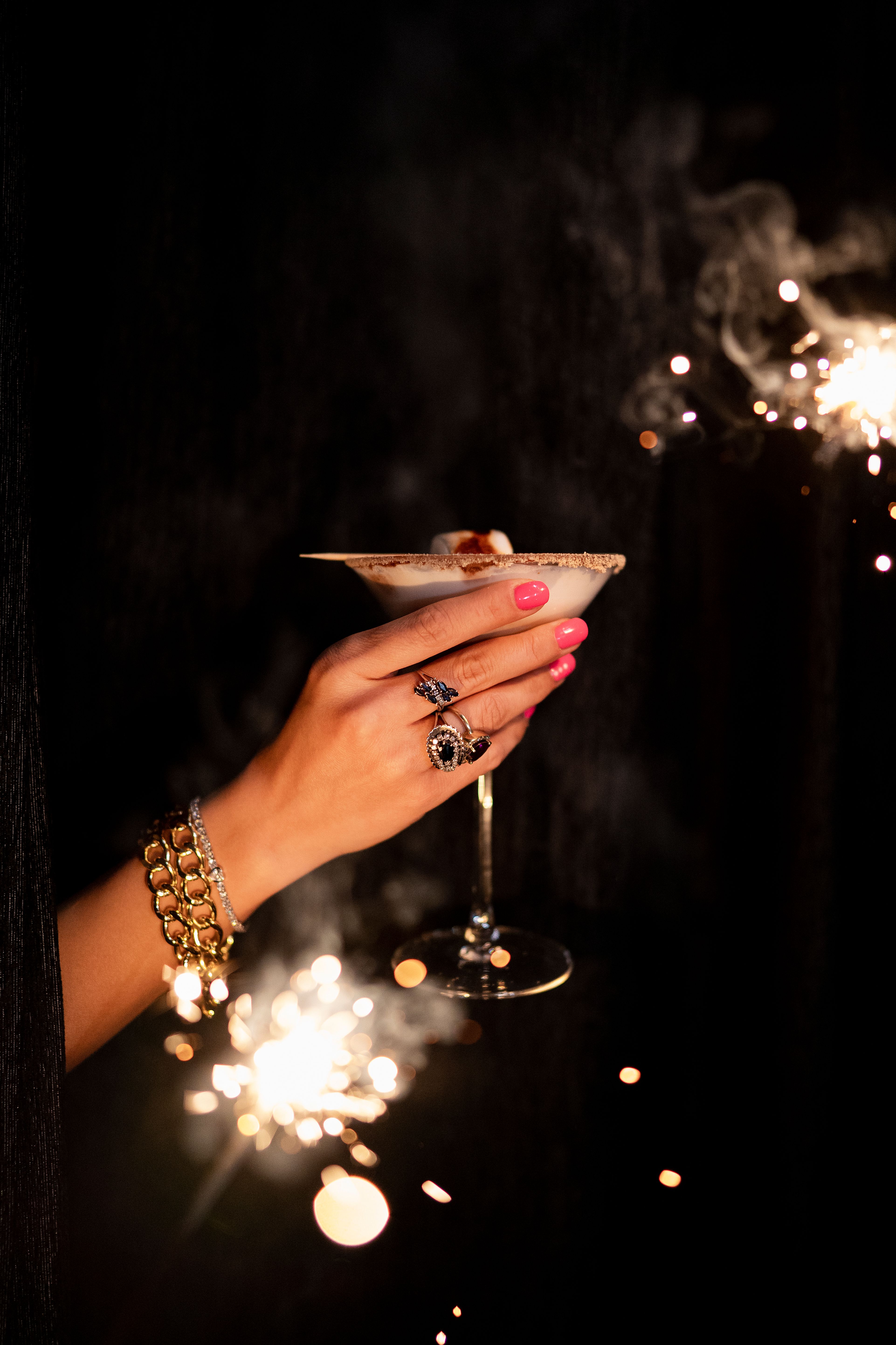 Woman Holding Drink Among Sparkles · Free Stock Photo