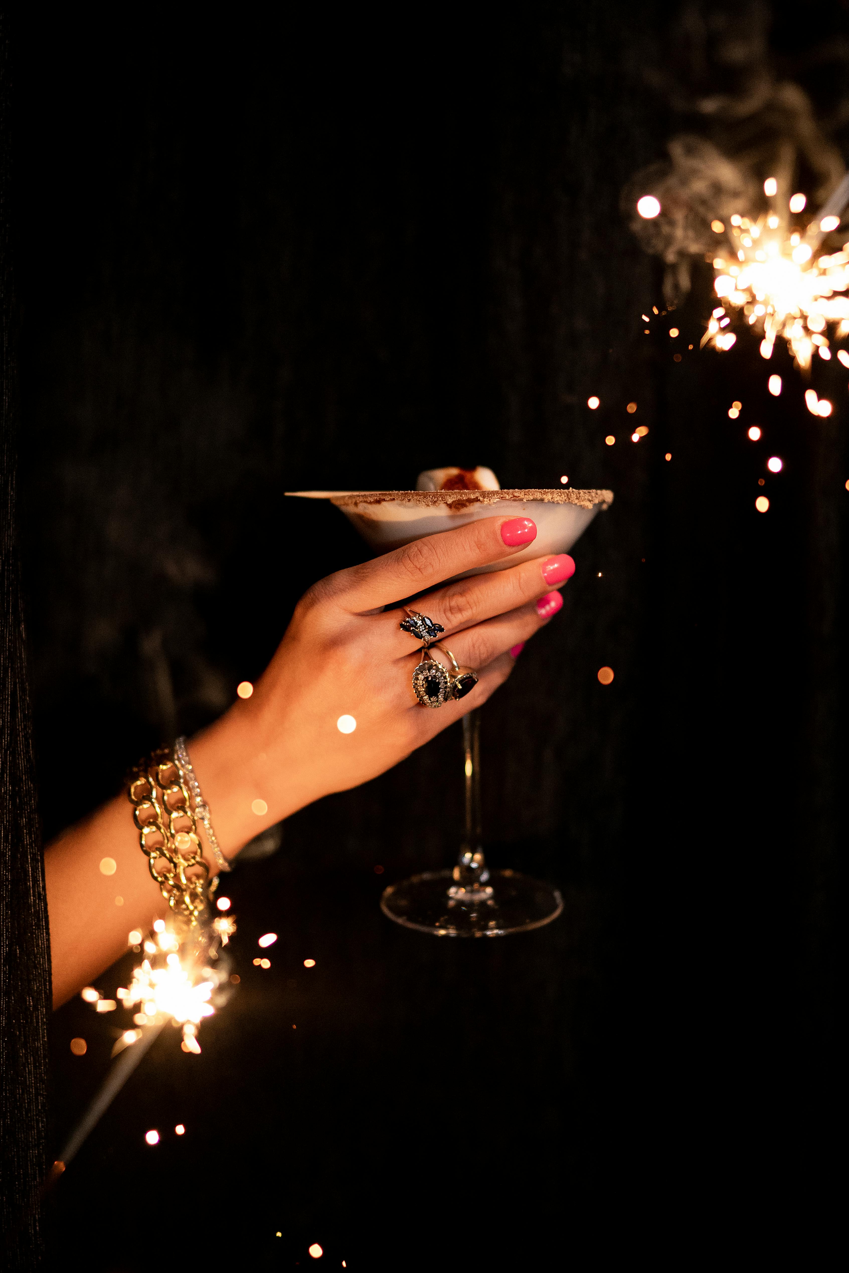 Hand with Drink among Sparklers · Free Stock Photo