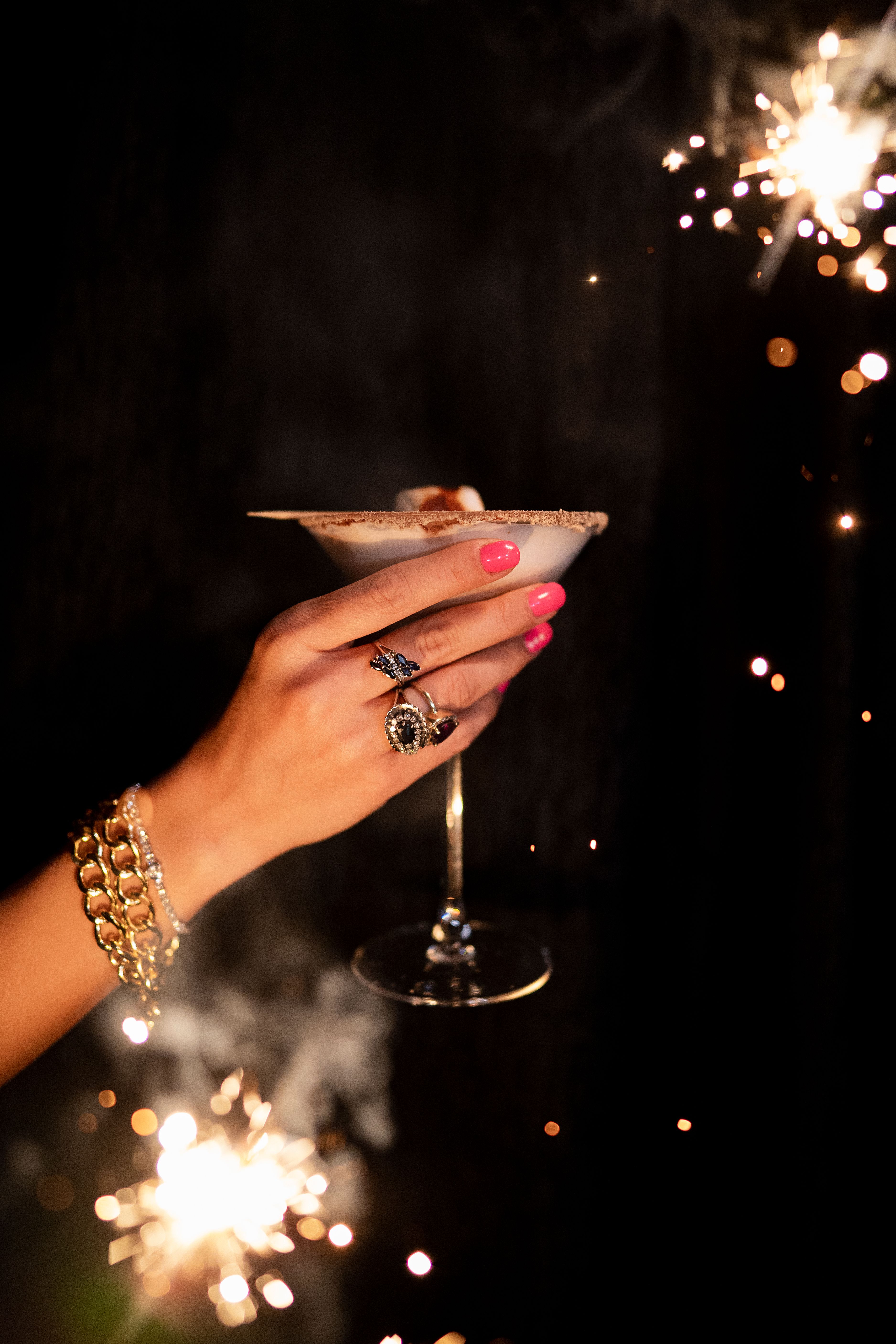 Woman Holding Drink Among Sparkles · Free Stock Photo