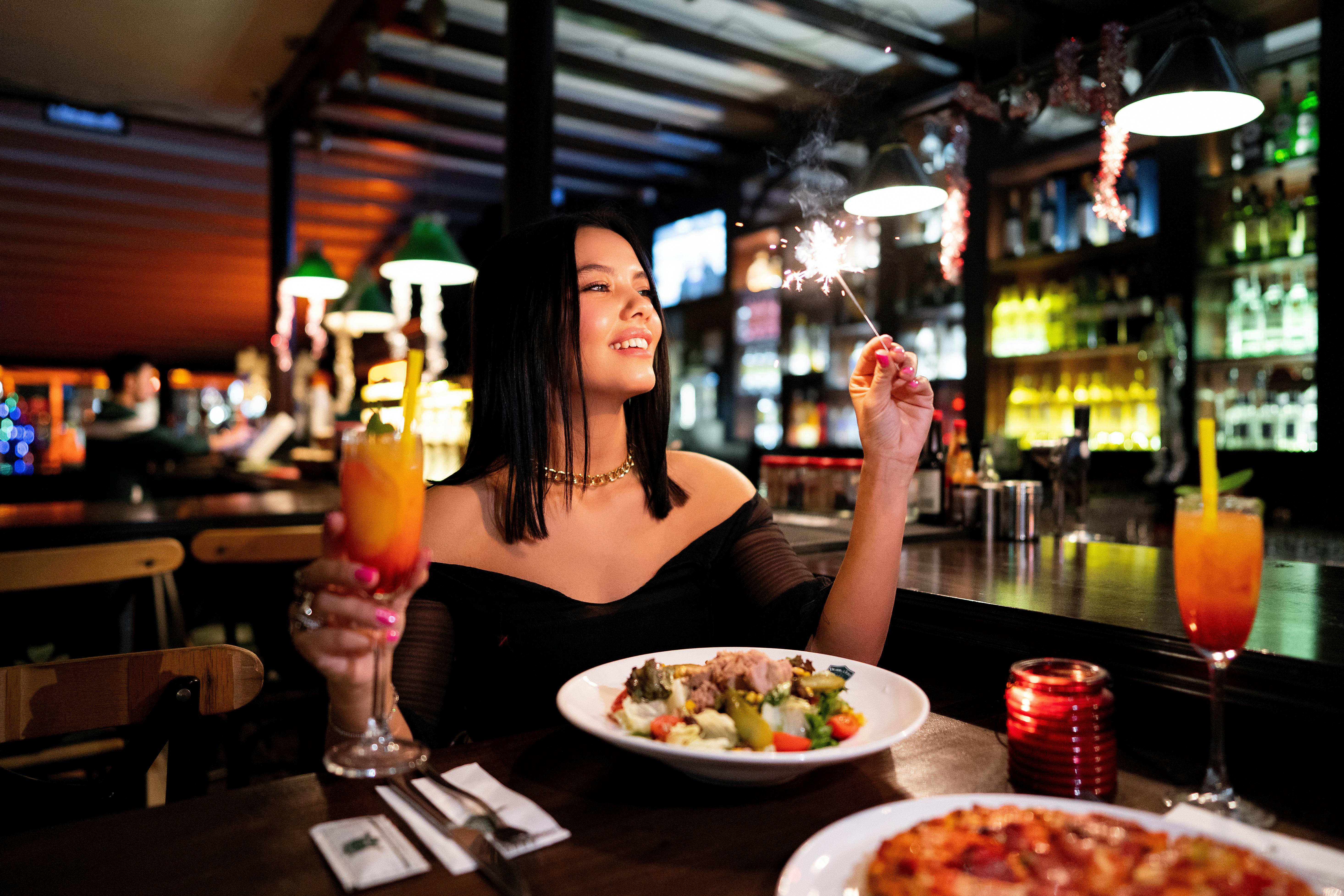 Joyful Brunette Having Cocktail and Meal in Bar · Free Stock Photo