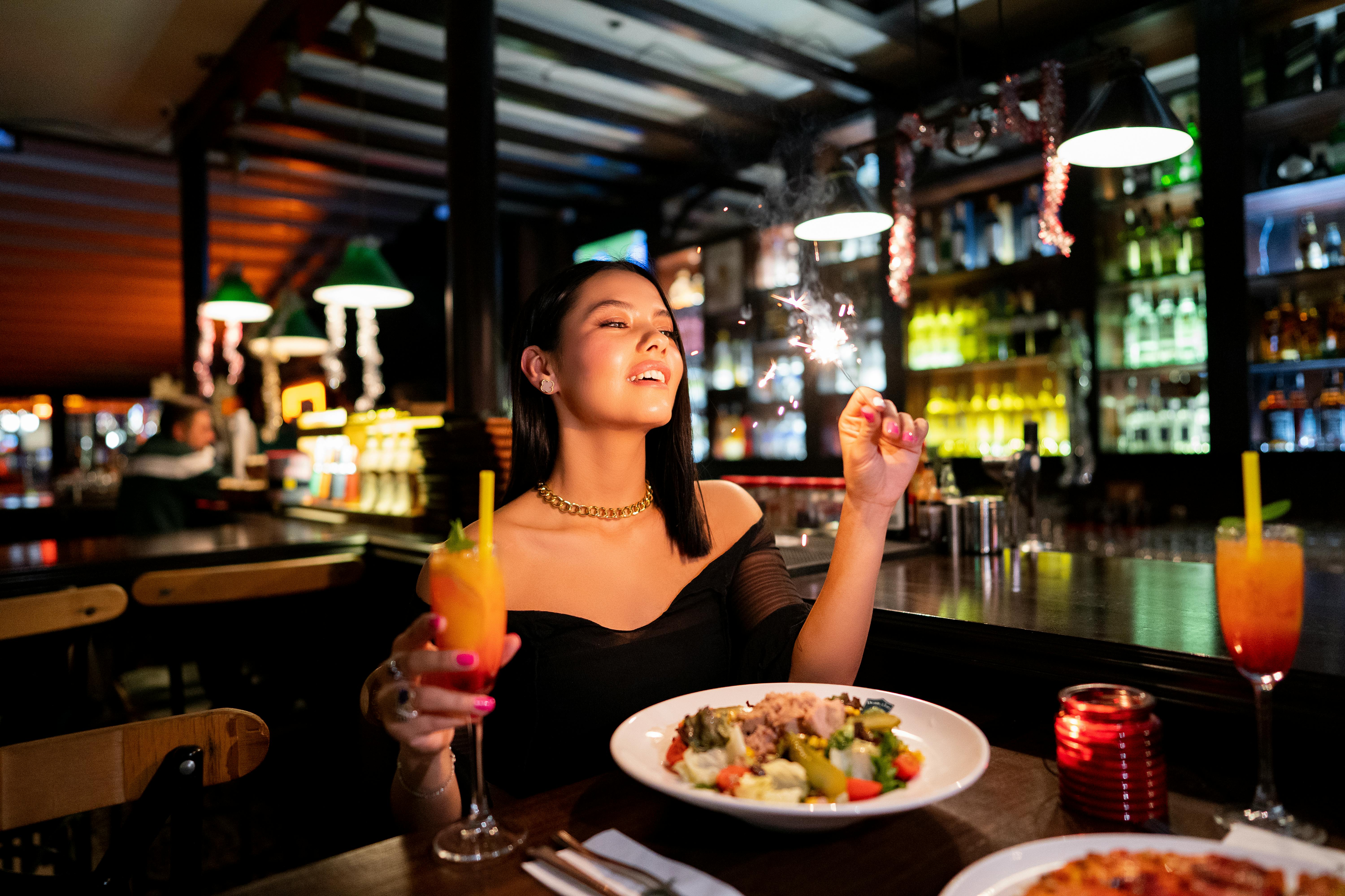 Woman Having Drink and Meal at Bar · Free Stock Photo