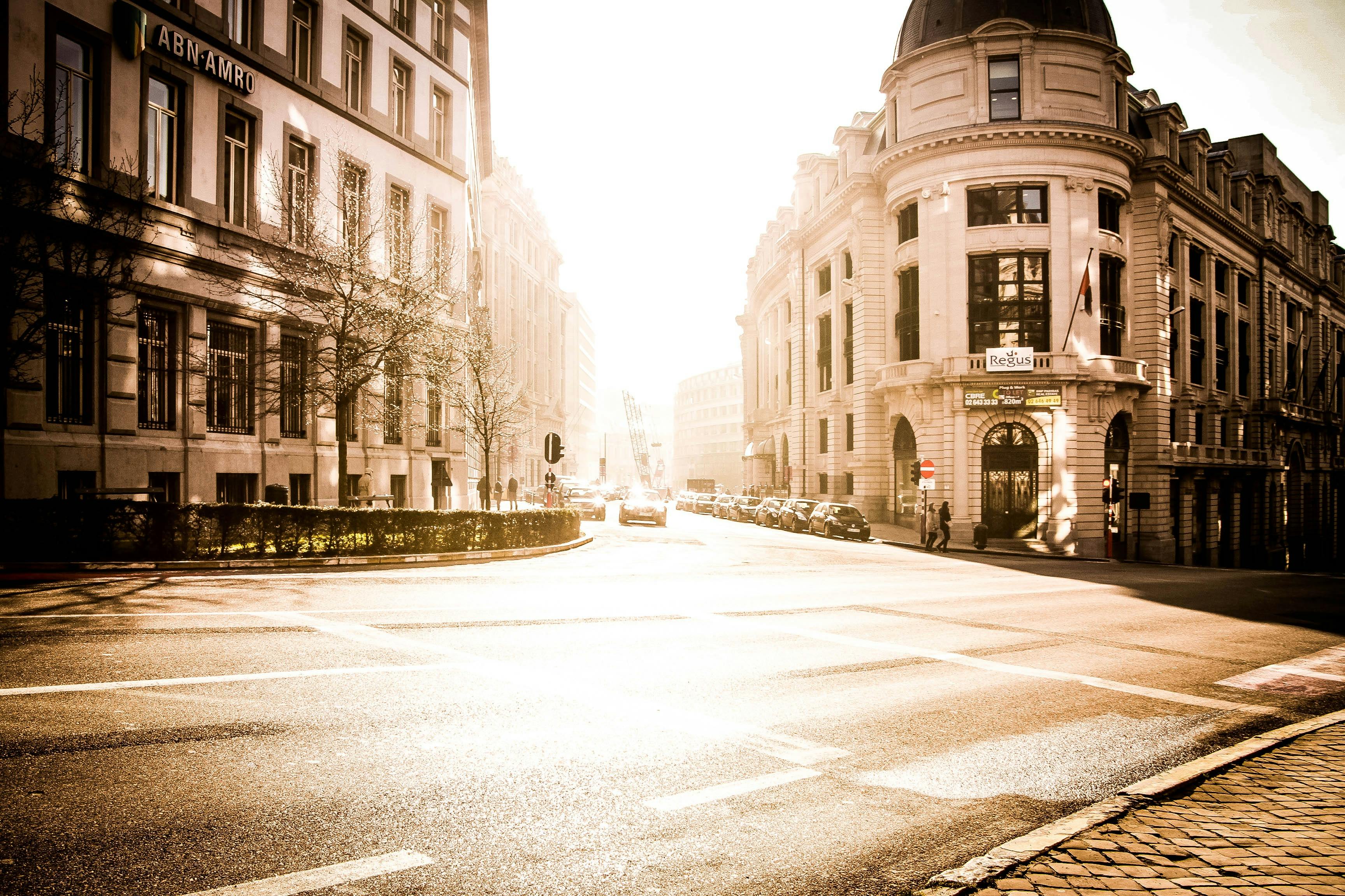 Black Asphalt Road Between Brown City Building Under White Skies during ...