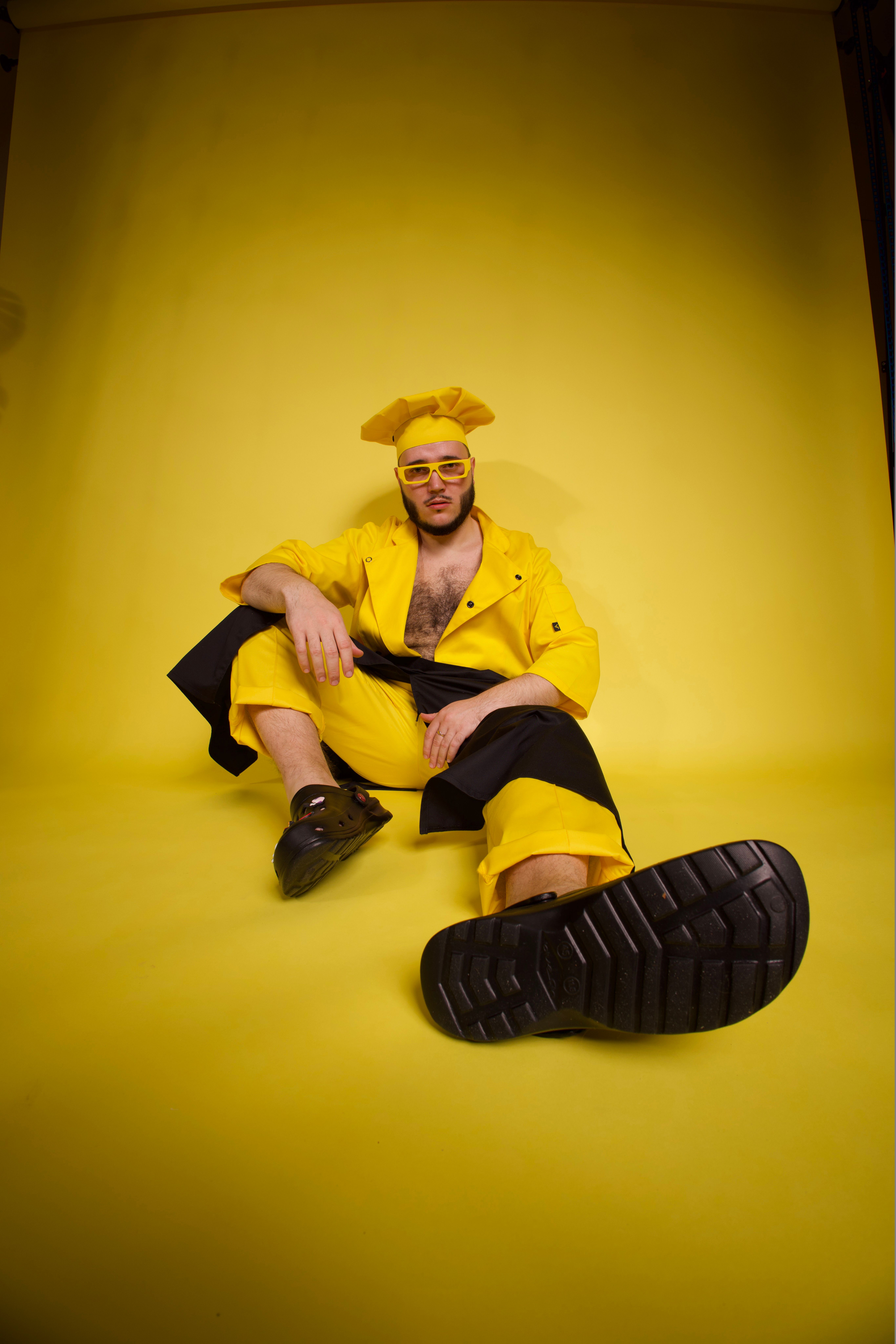 Man Posing in a Yellow Chef Outfit · Free Stock Photo