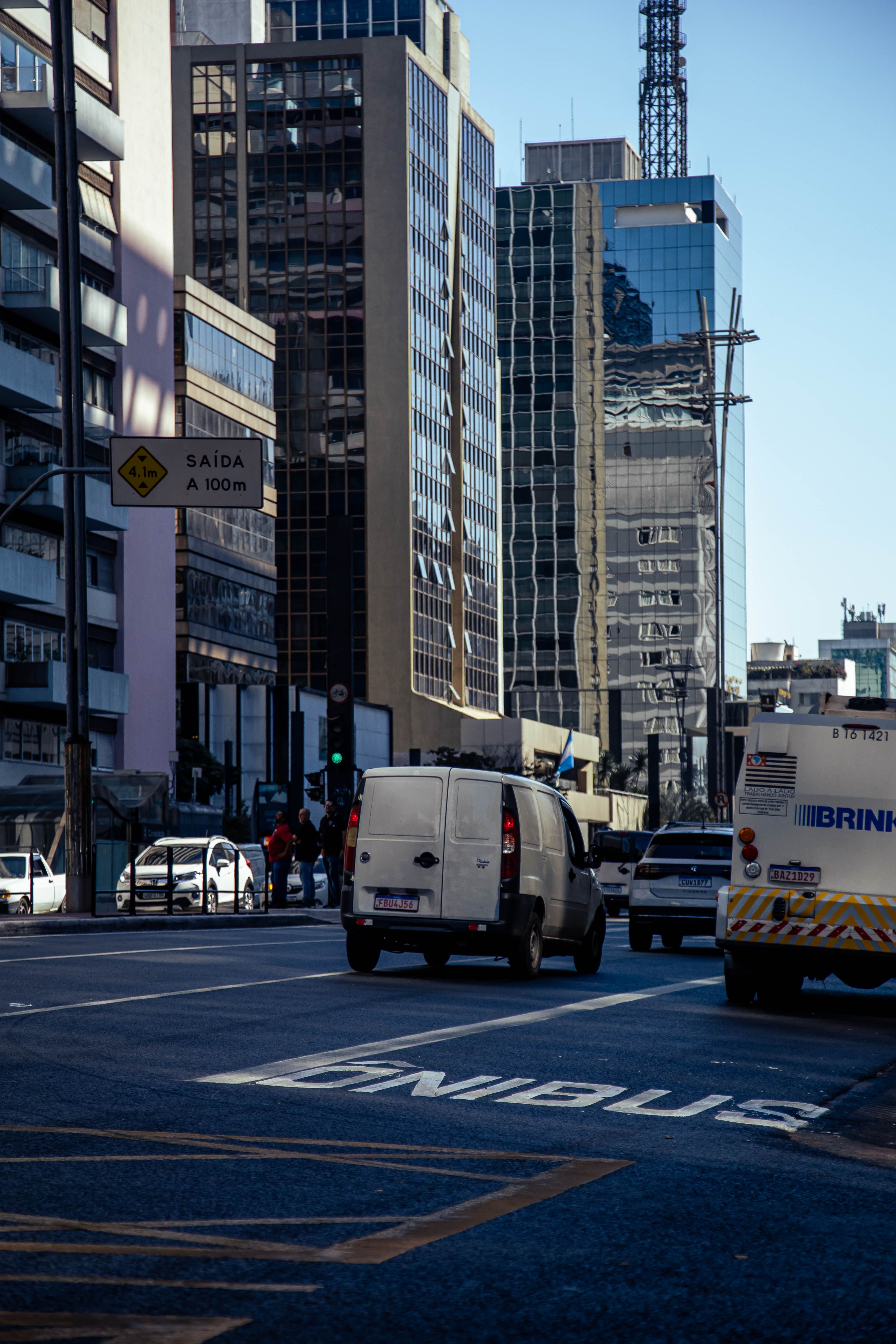 Man Sitting on High Rise Building Taking Photo Below · Free Stock Photo