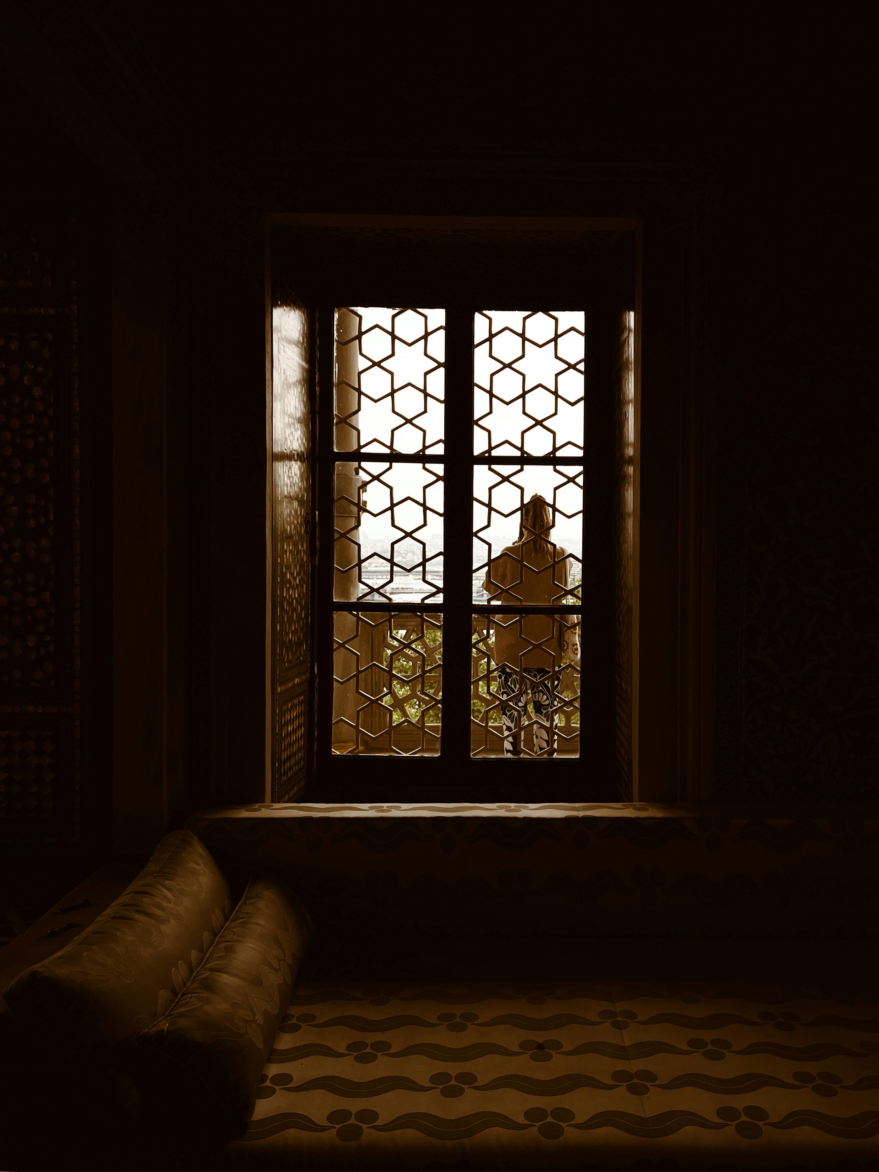 Woman Standing behind Room Window and Bars · Free Stock Photo