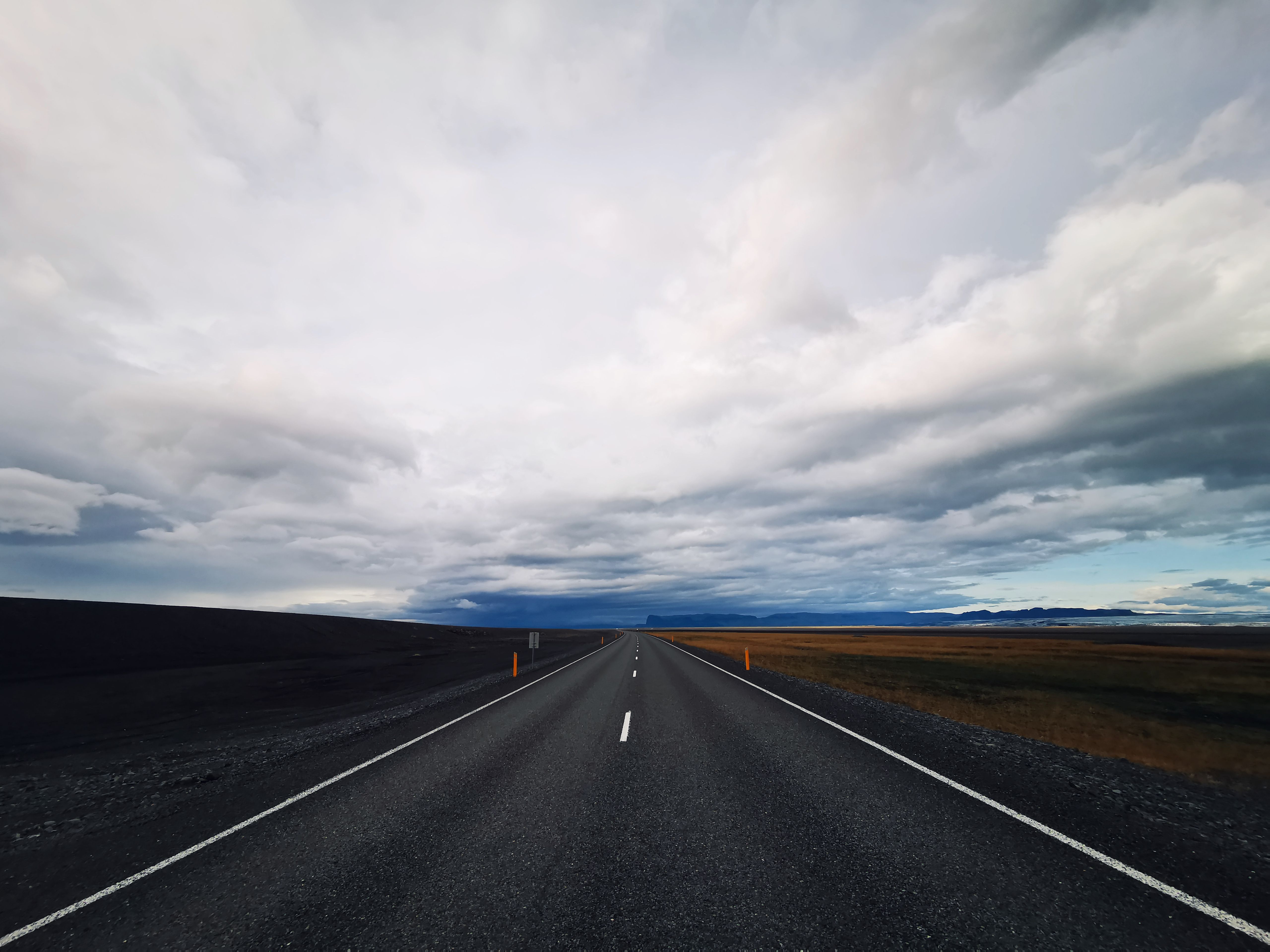 A straight road through the open fields in Iceland · Free Stock Photo