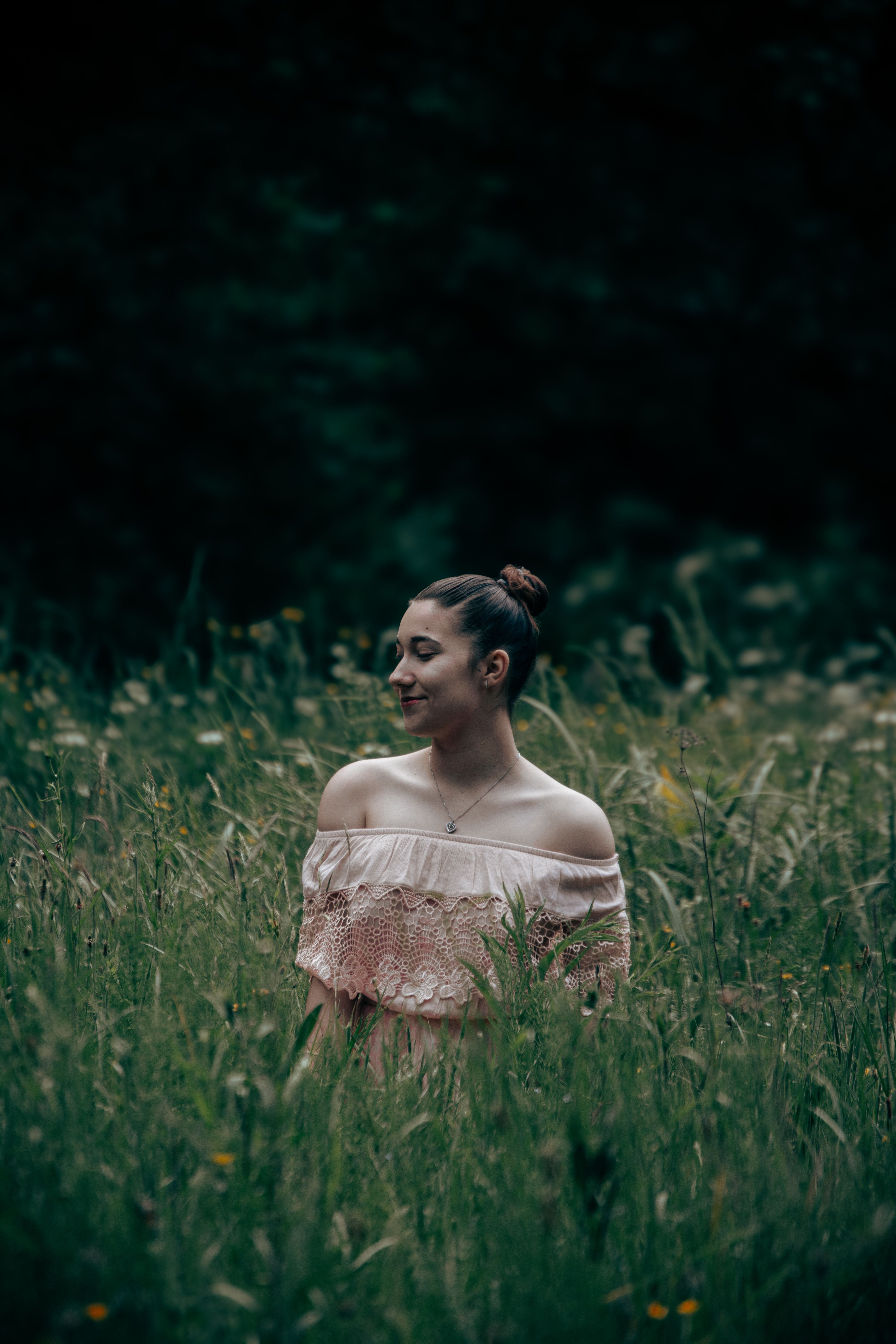 Woman in Off Shoulder Top Standing in Grass Field · Free Stock Photo