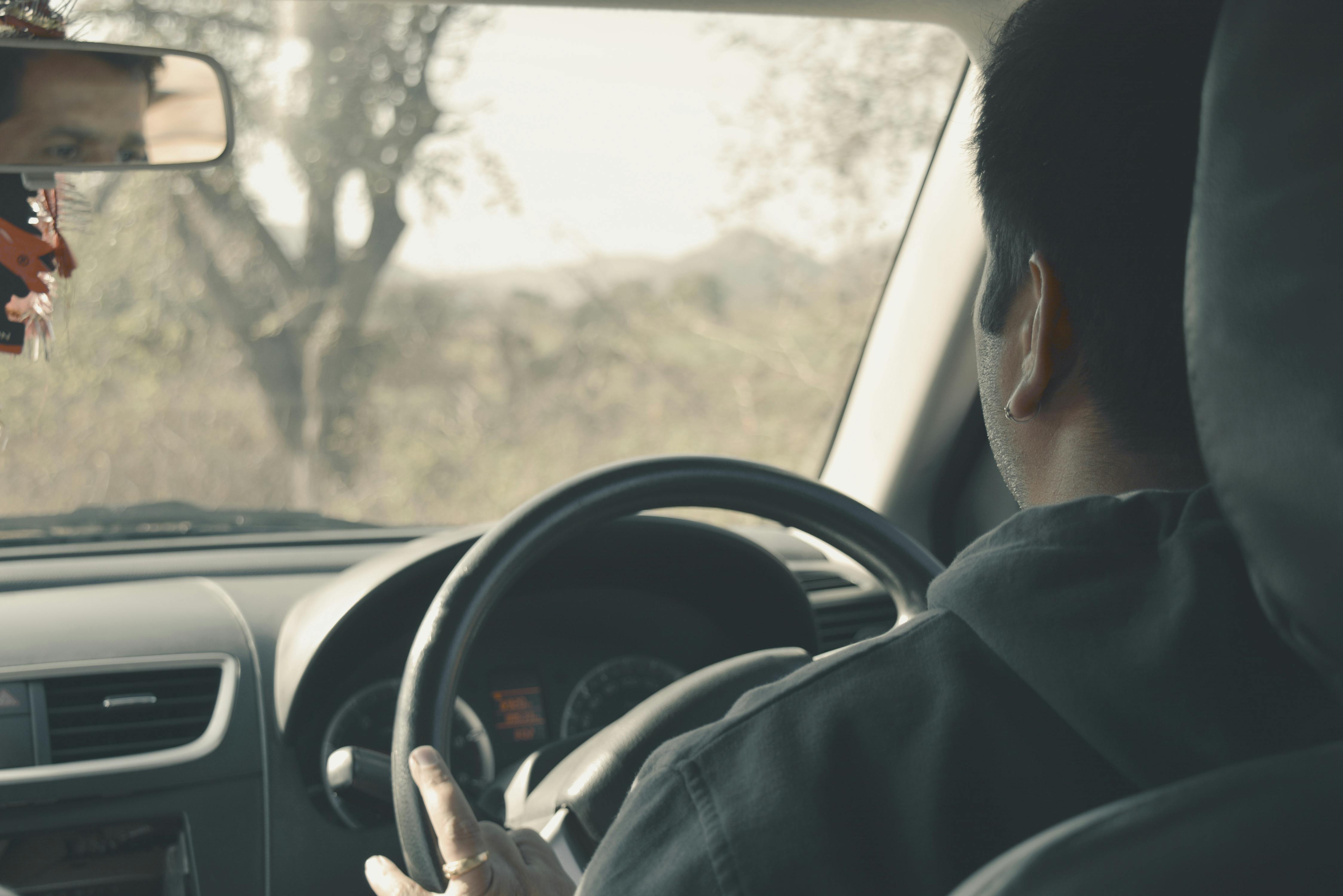 Rear View of Woman Looking Through Car Window · Free Stock Photo Rear View of Woman Looking Through Car Window · Free Stock Photo