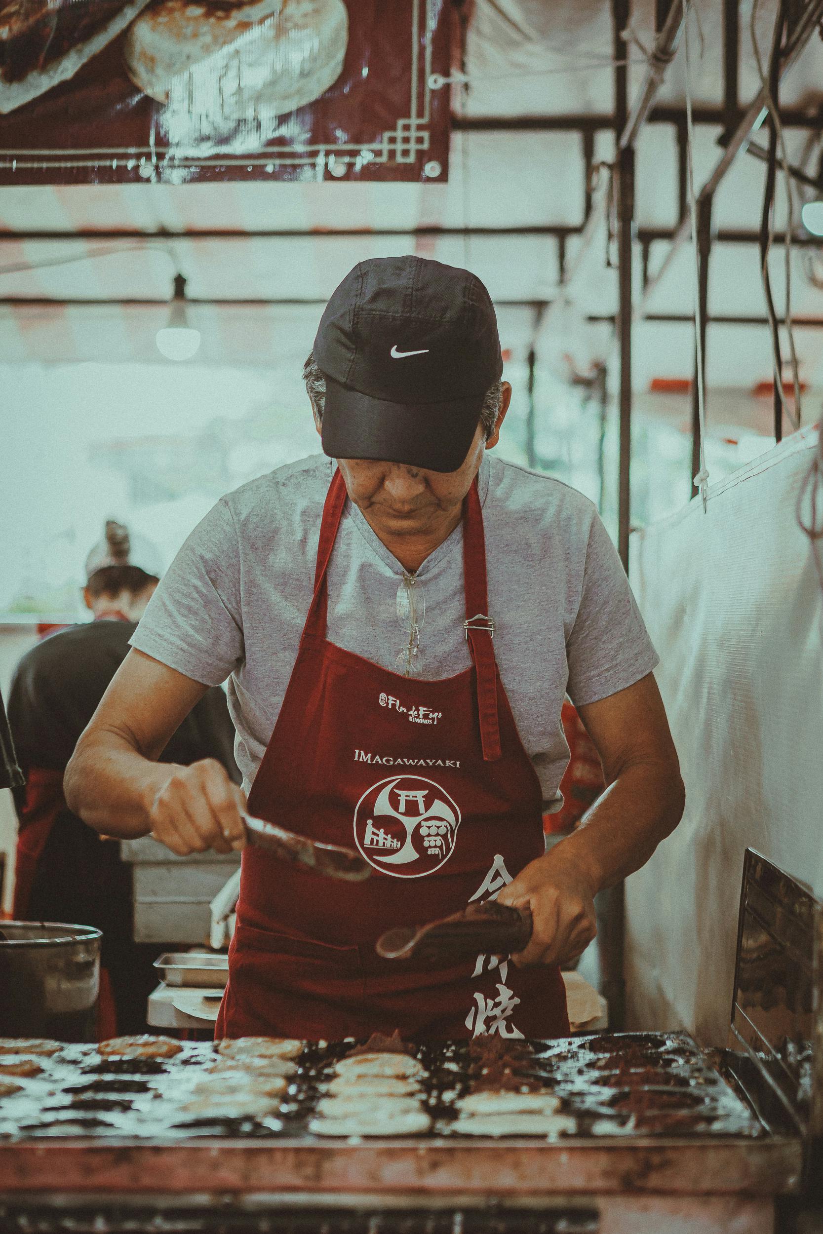 Man Cooking Inside a Food Stall · Free Stock Photo