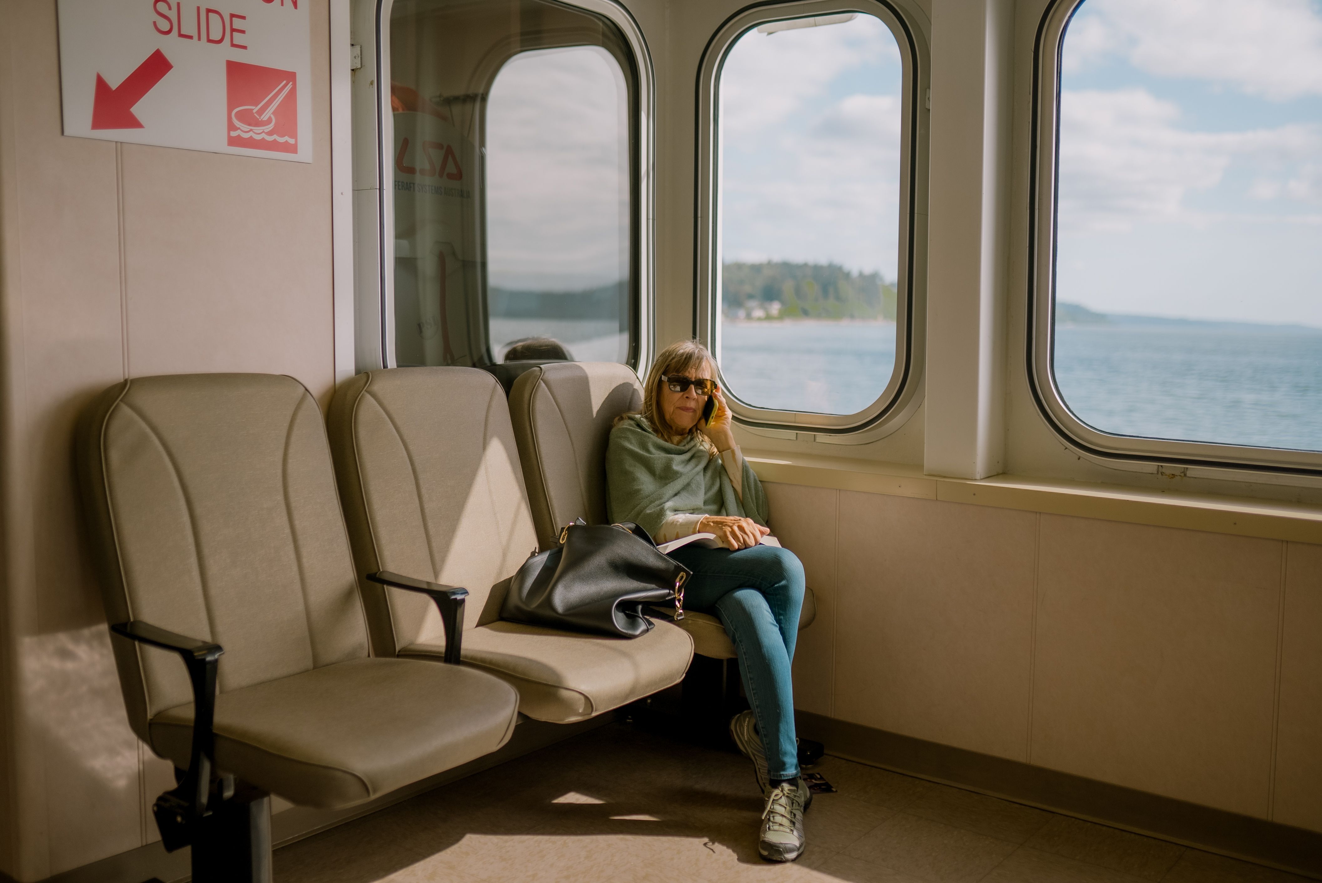 Elderly Woman Sitting on Ferry · Free Stock Photo