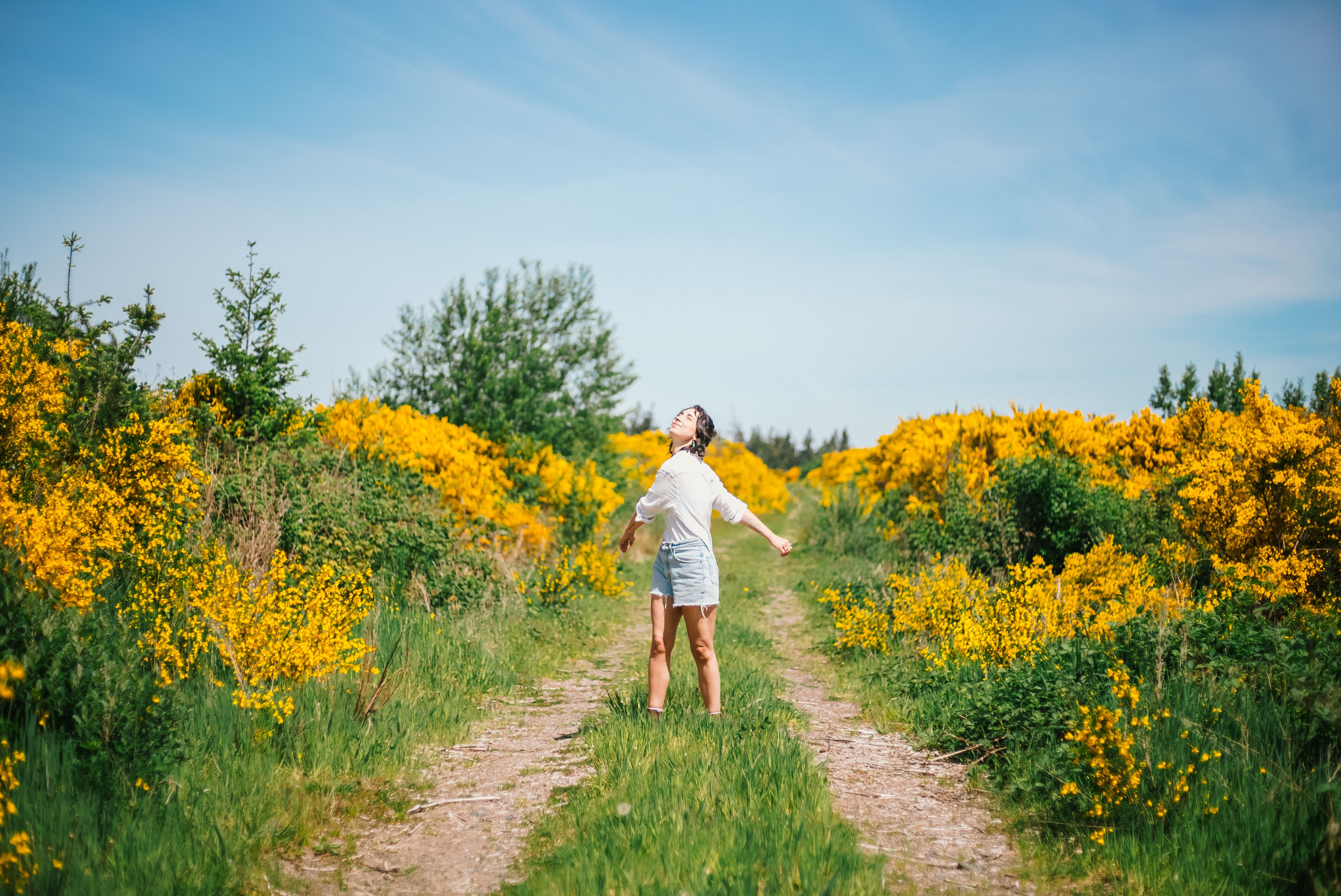 Woman Taking a Deep Breath Against Rural Landscape · Free Stock Photo