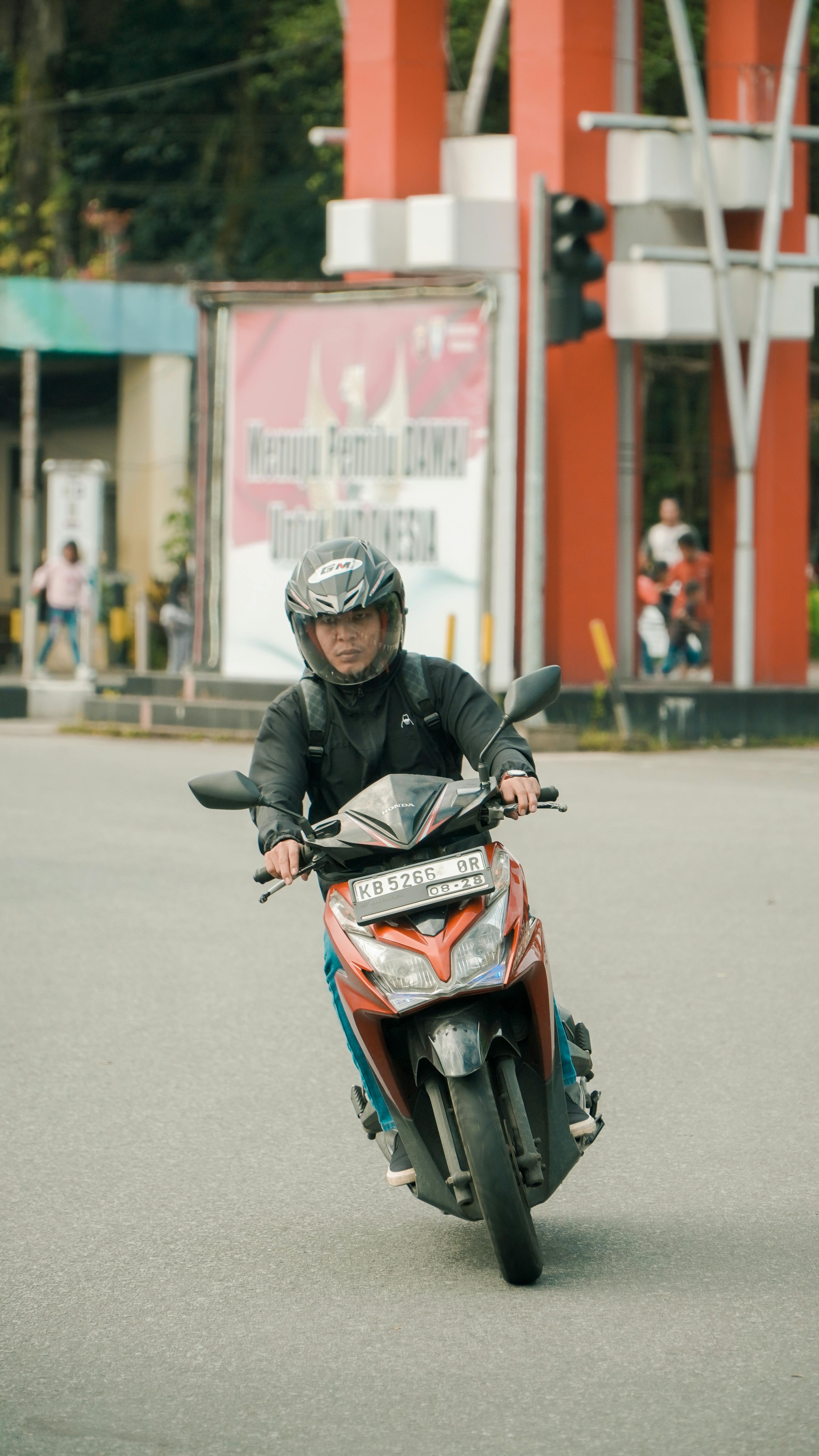Man Riding a Scooter · Free Stock Photo