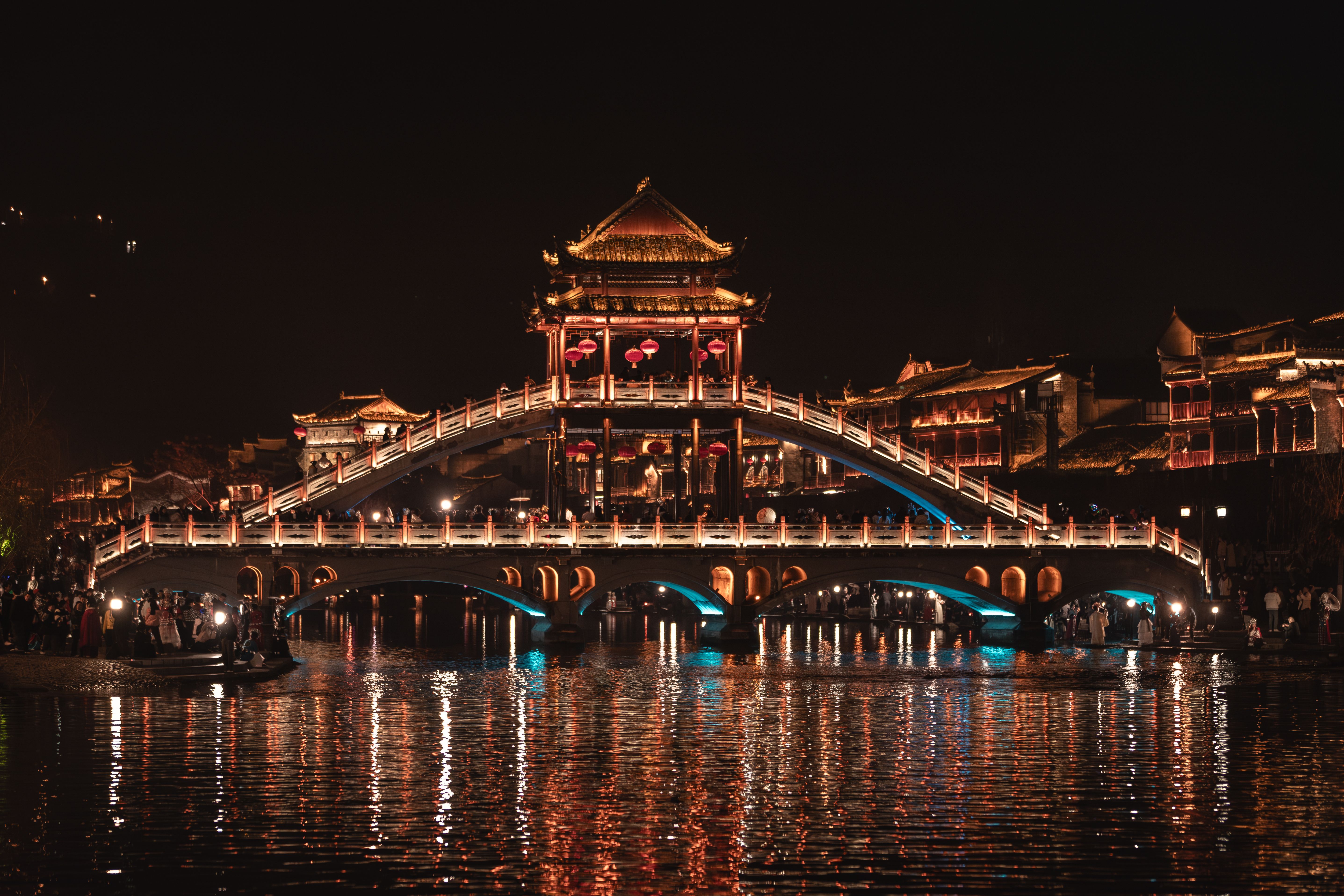 A bridge over water at night with lights · Free Stock Photo