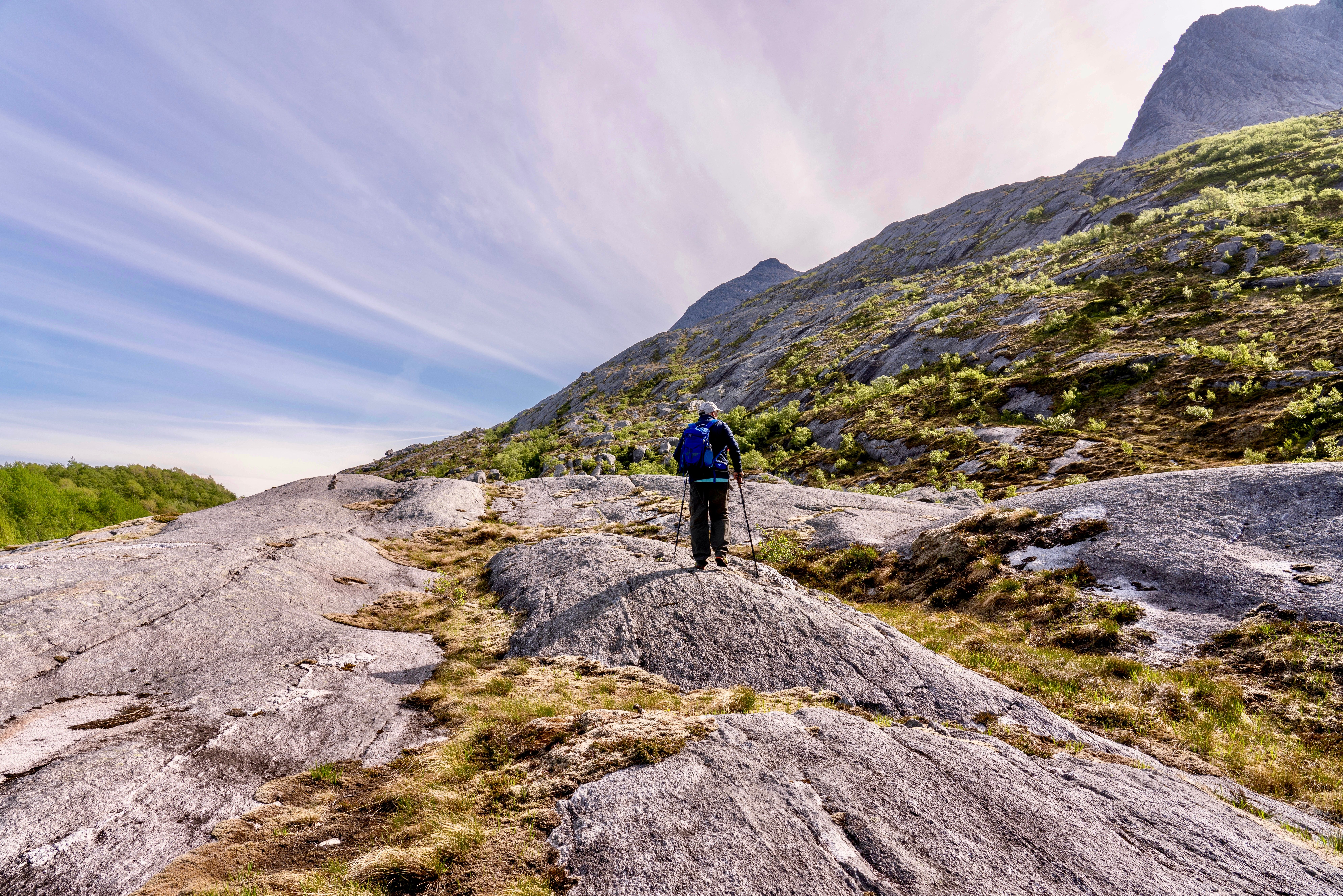 A person walking on a rocky path in the mountains · Free Stock Photo