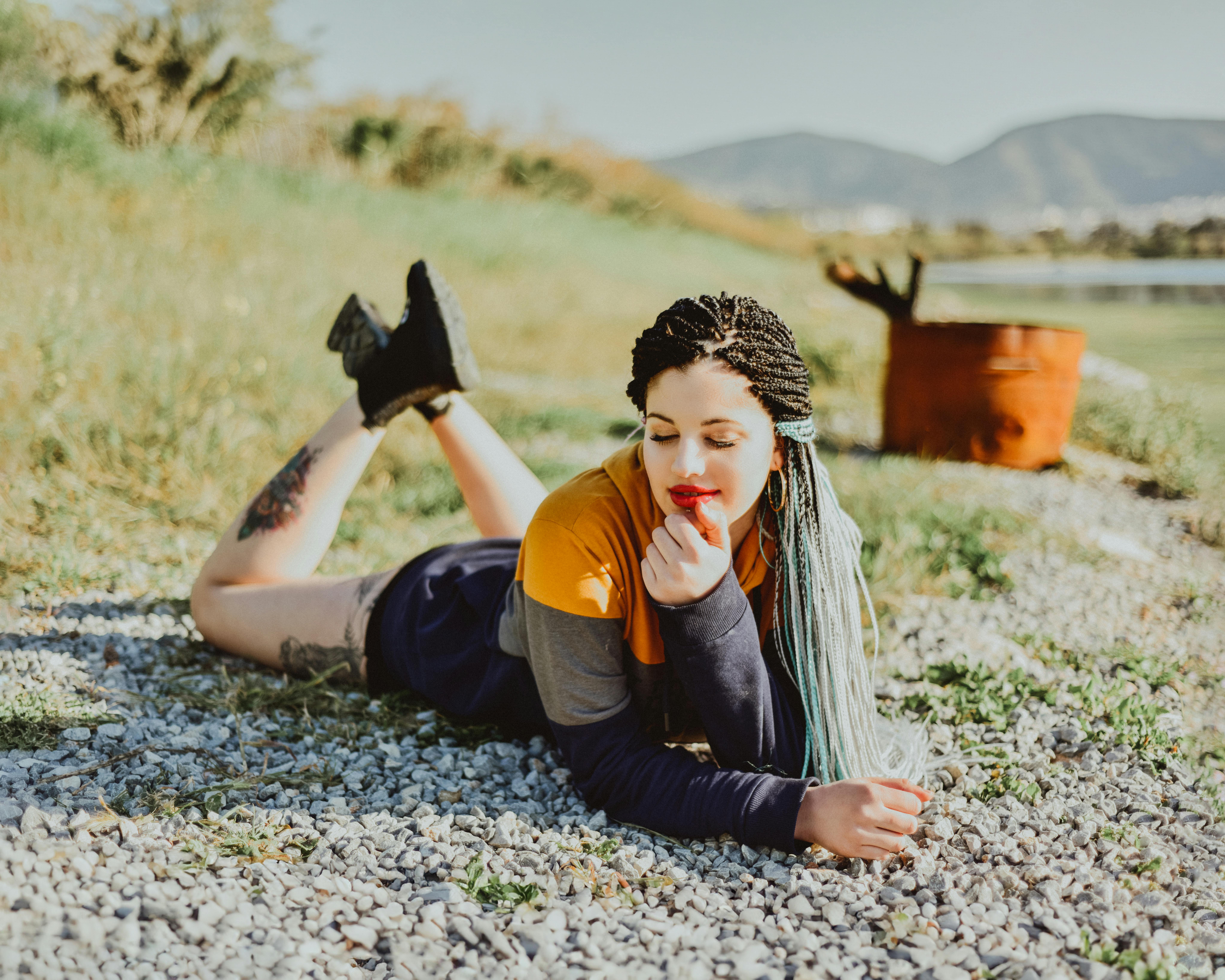 Woman on the Ground Below a Hill · Free Stock Photo