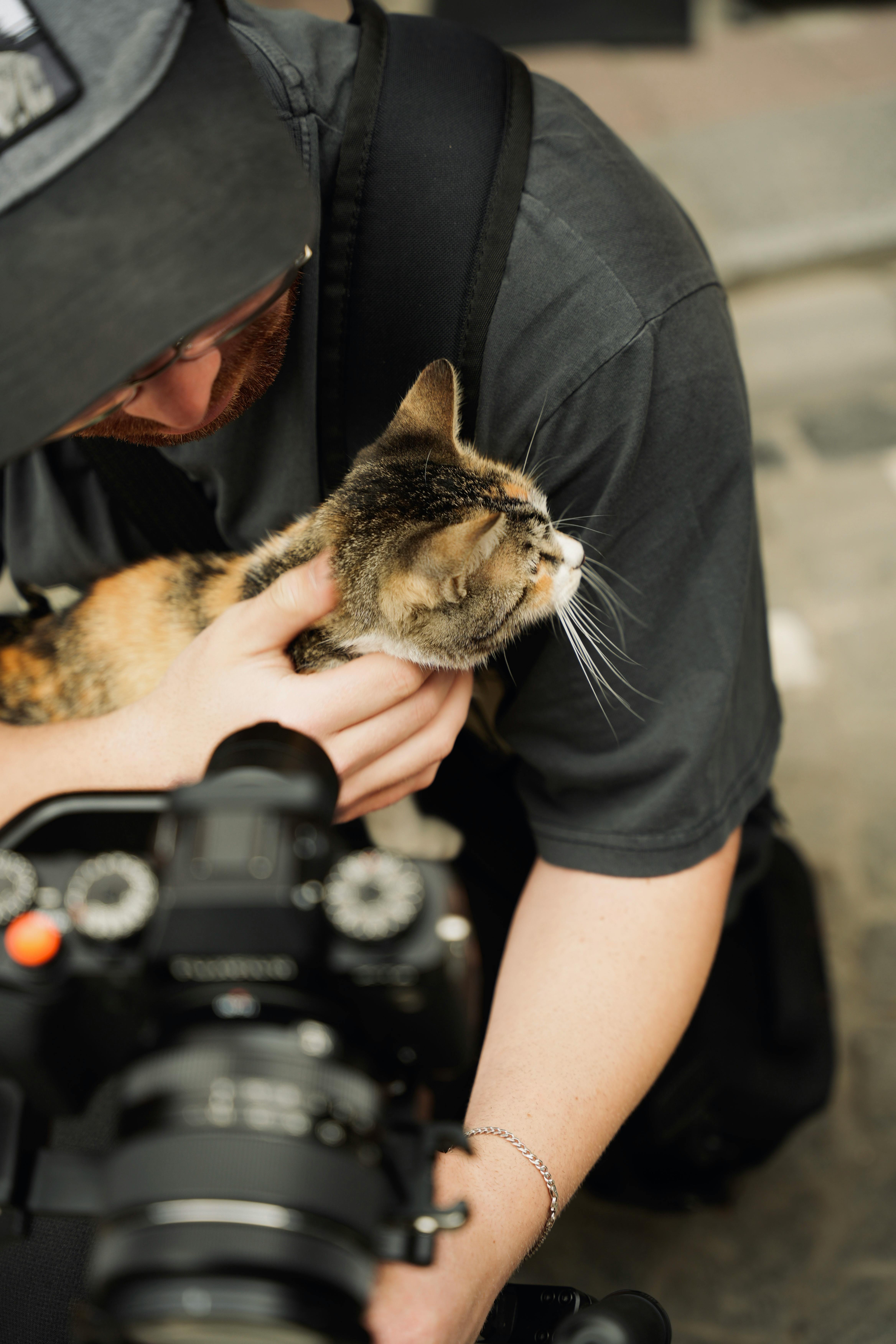 Man Holding Cat and Camera · Free Stock Photo