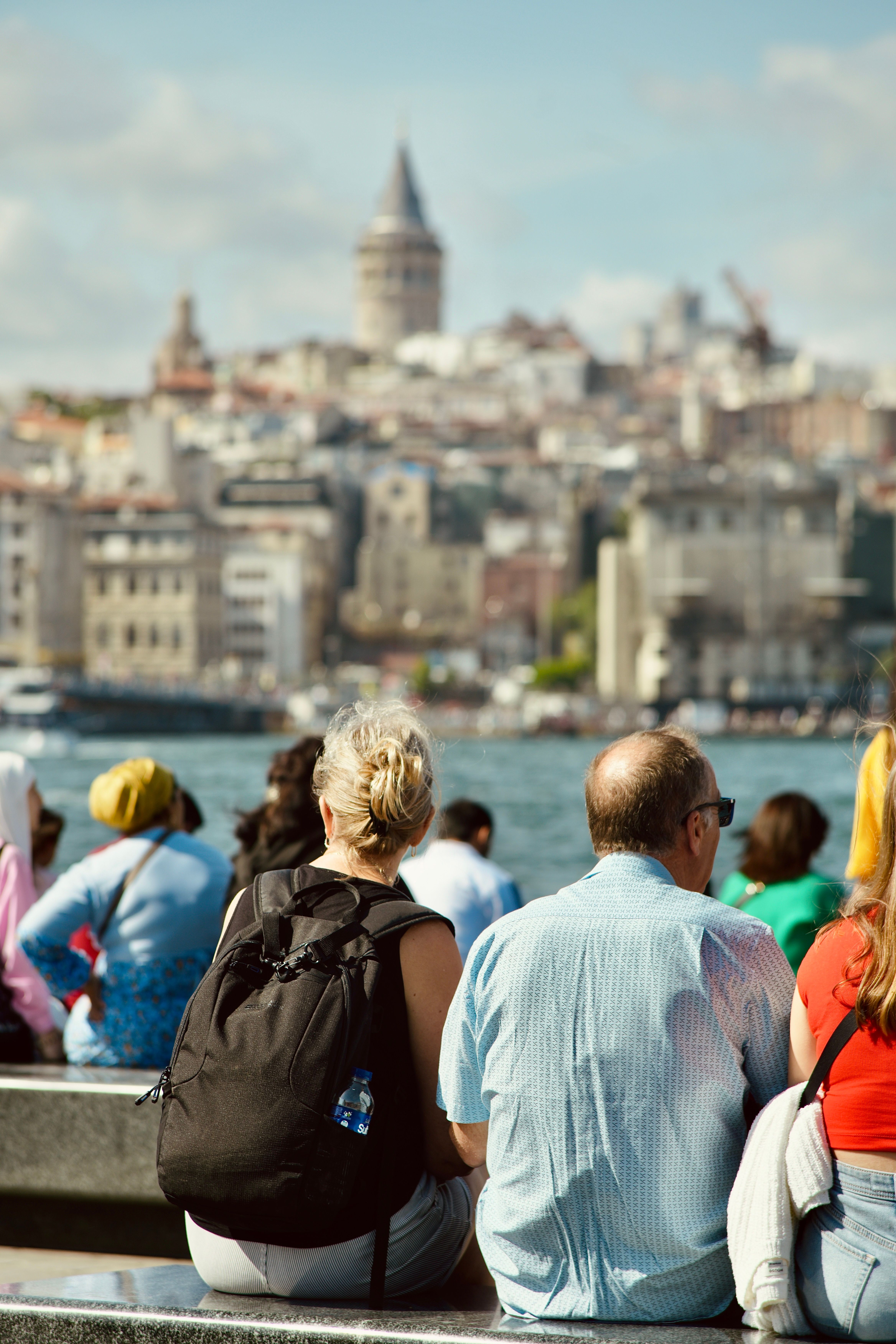 People Sitting on Sea Shore with Galata Tower behind in Istanbul · Free ...