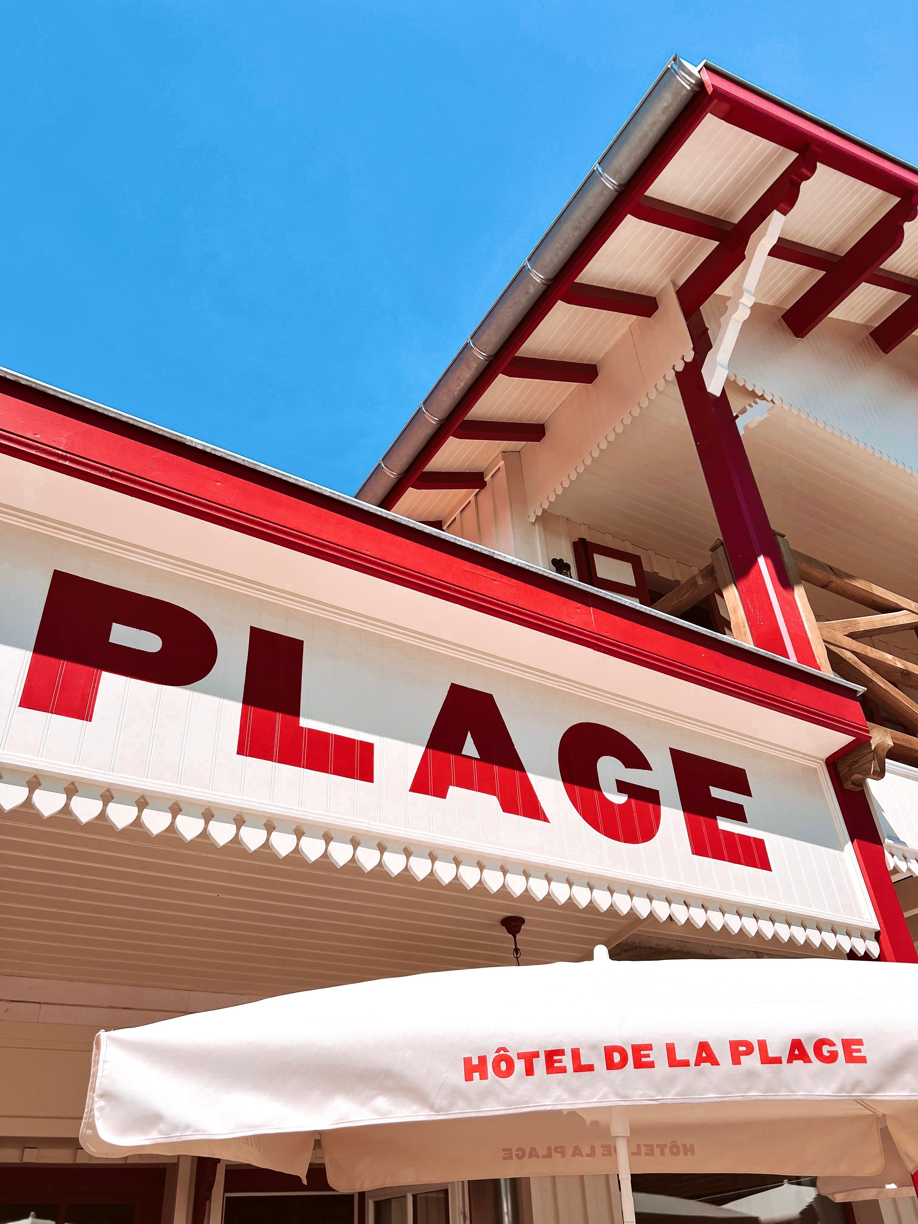 Exterior of a White and Red Hotel Building · Free Stock Photo