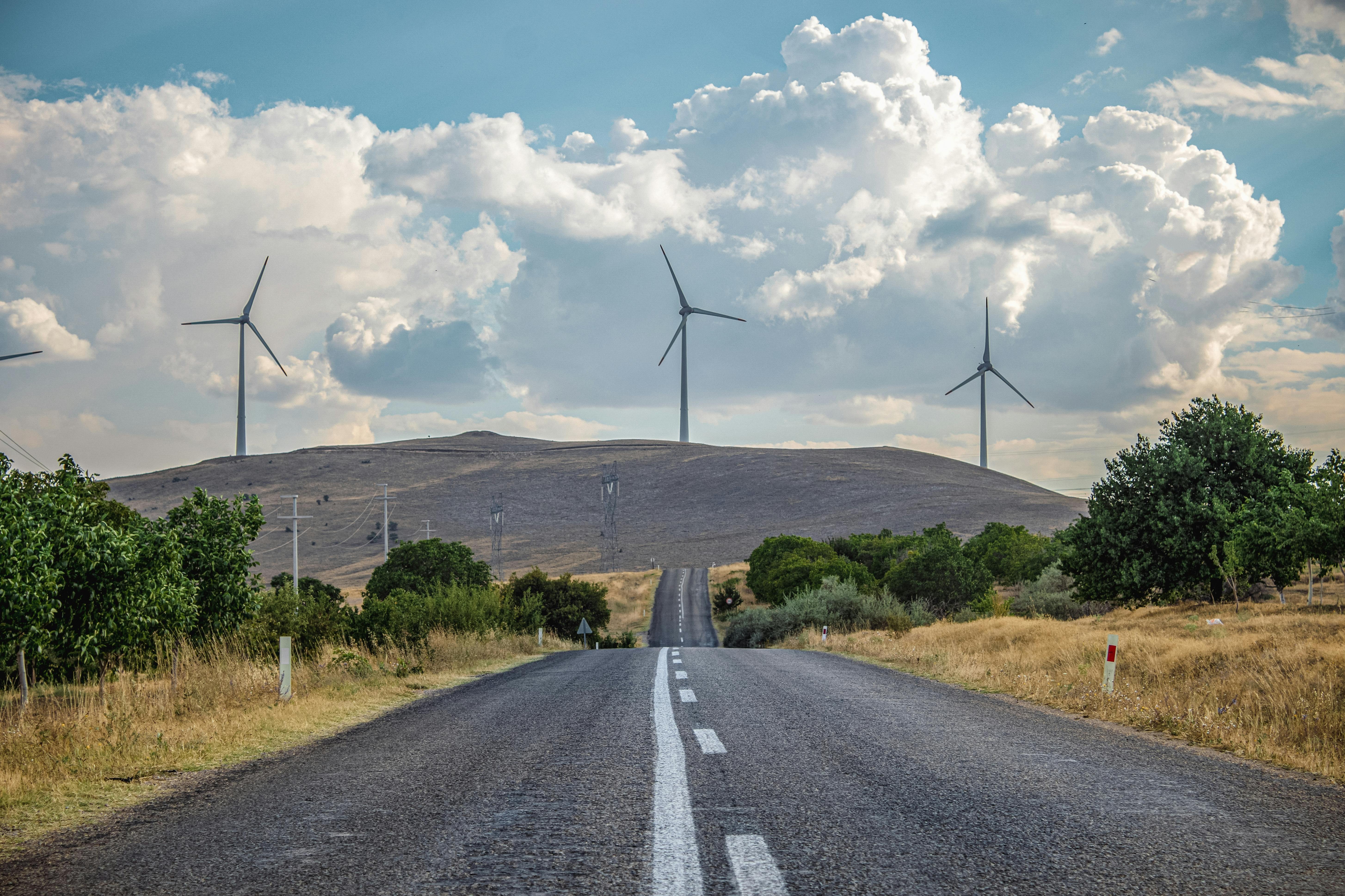 Wind Turbines Above a Winding Road · Free Stock Photo