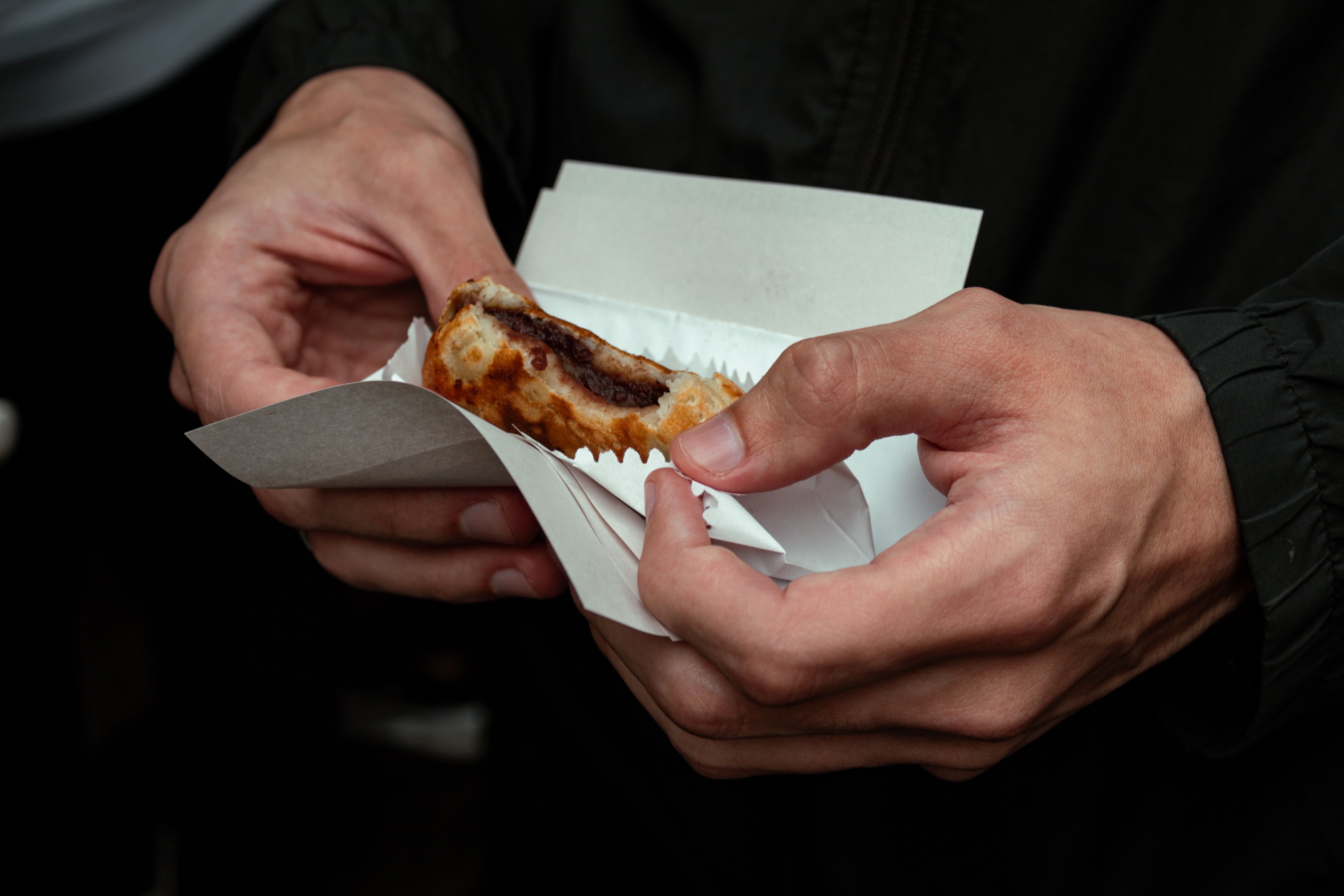Hands of a Person Eating Sweet Pastry · Free Stock Photo