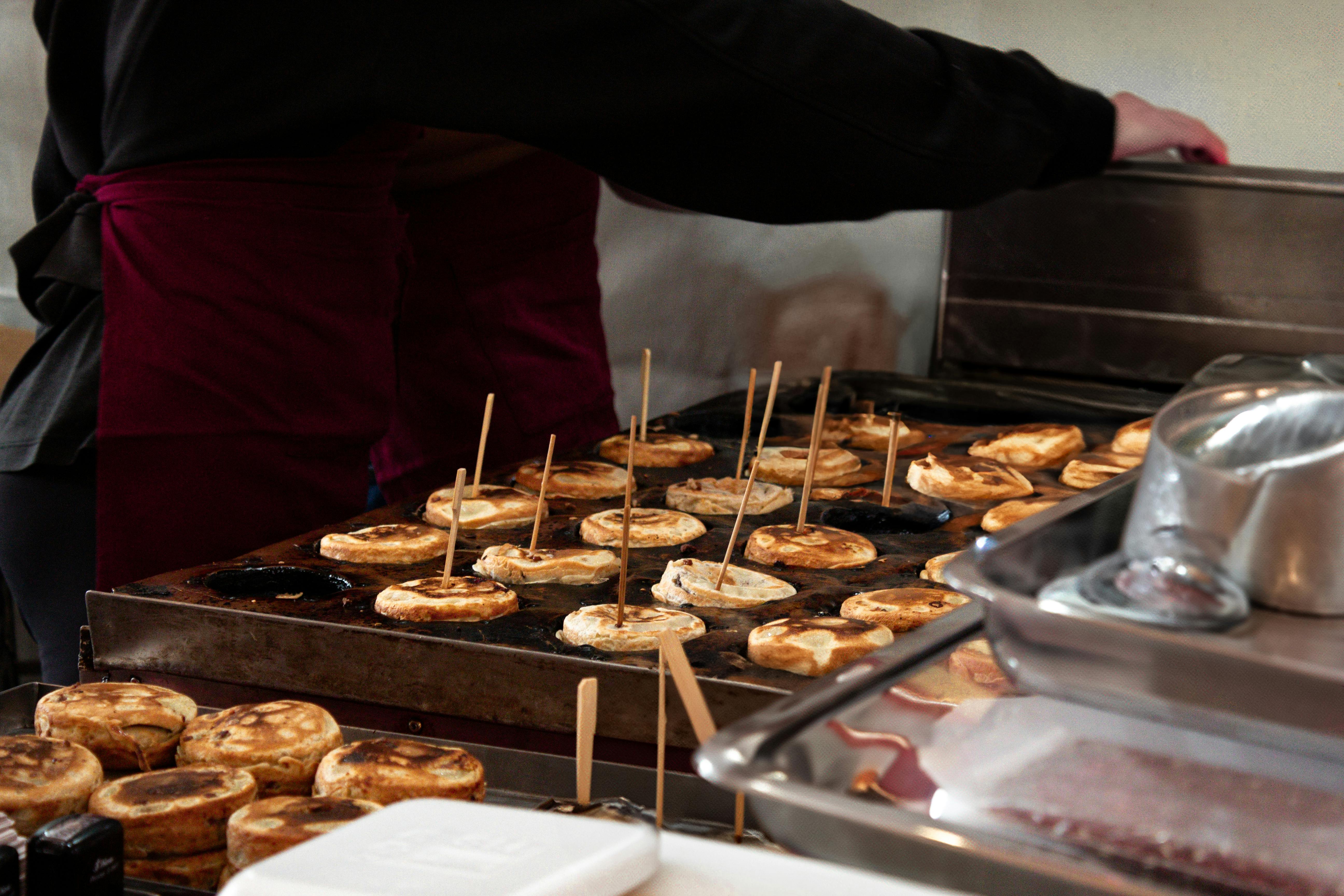 Person Preparing Rows of Pancakes · Free Stock Photo