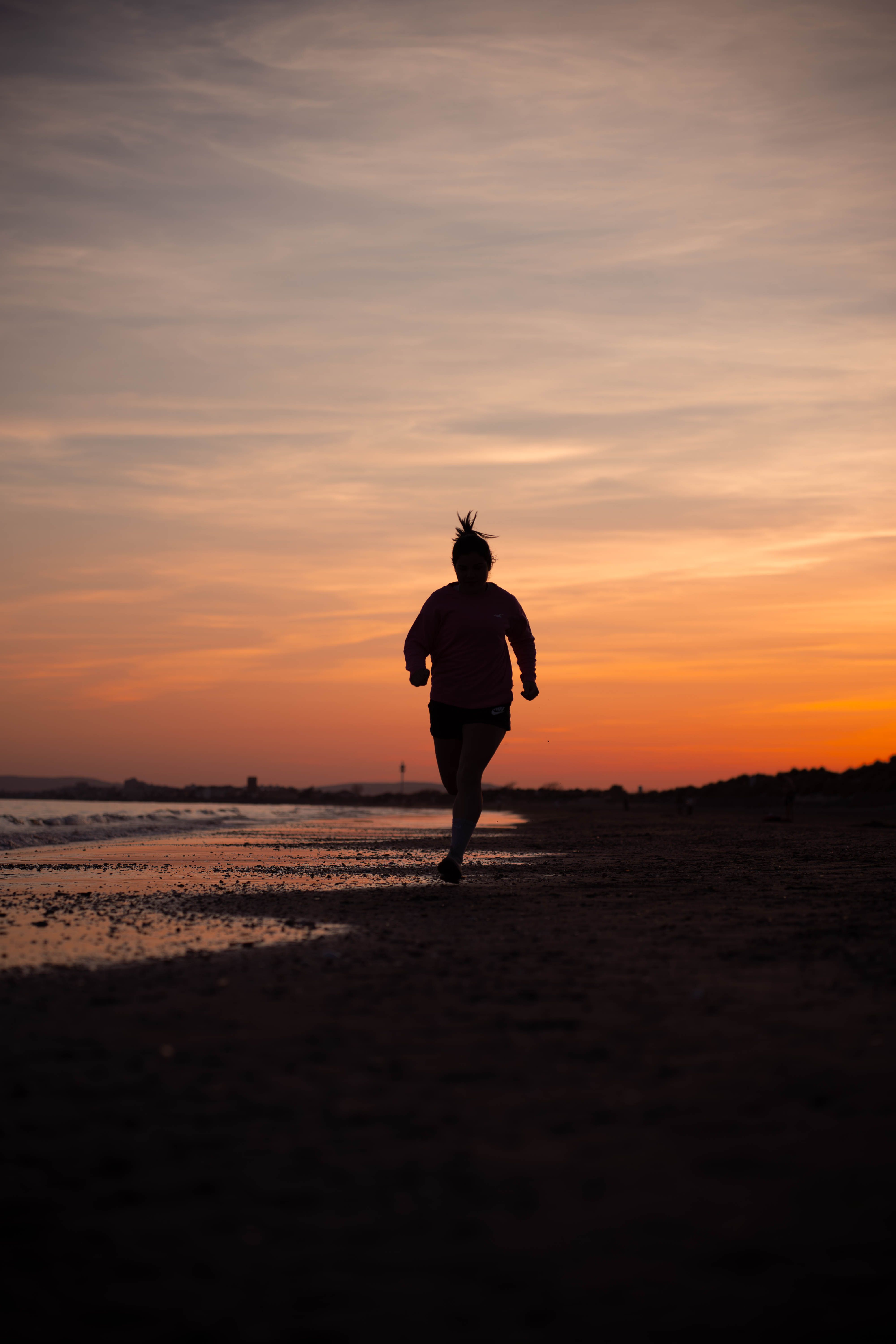 Back View of a Woman Running on a Beach · Free Stock Photo