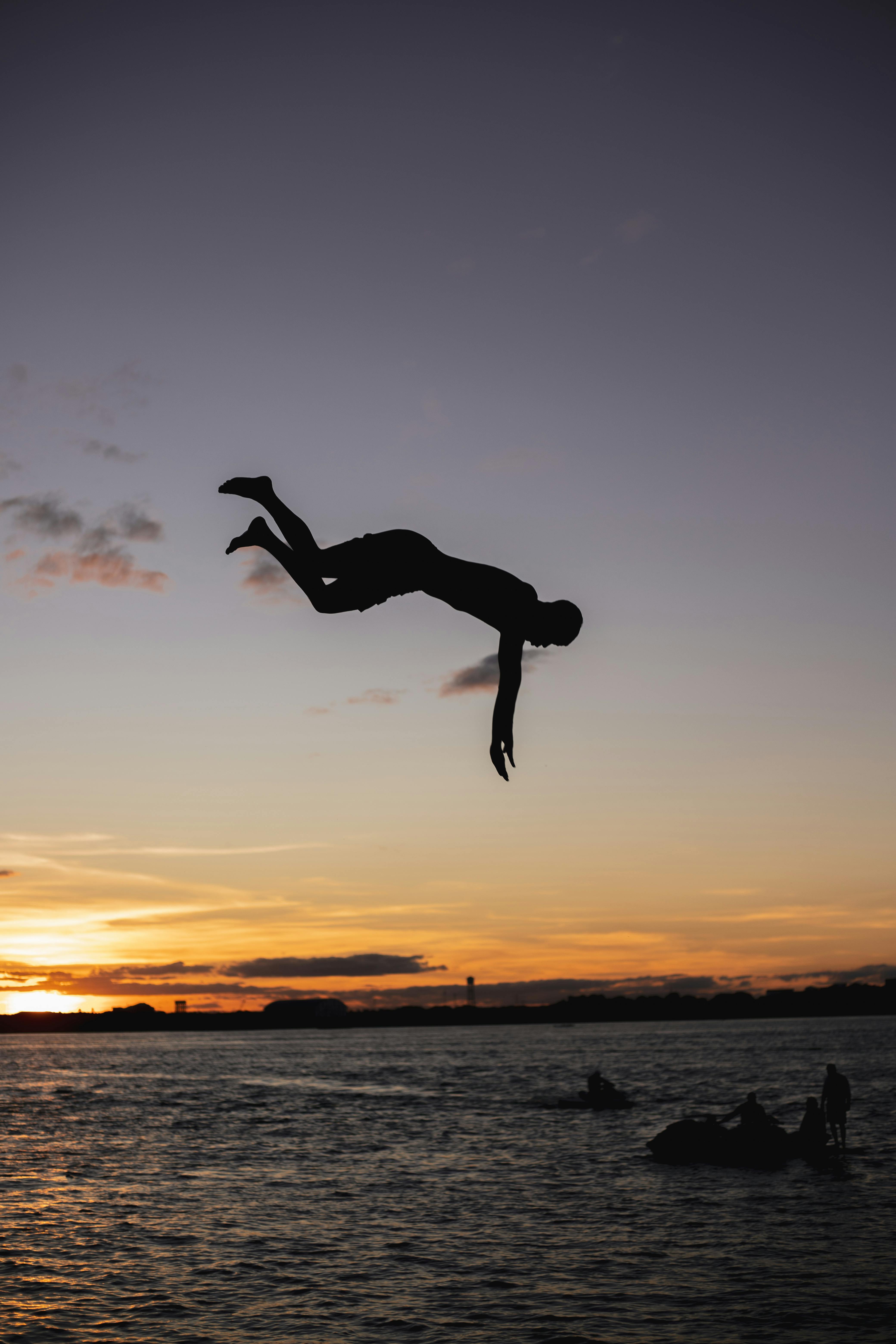 Man Diving into Sea at Sunset · Free Stock Photo
