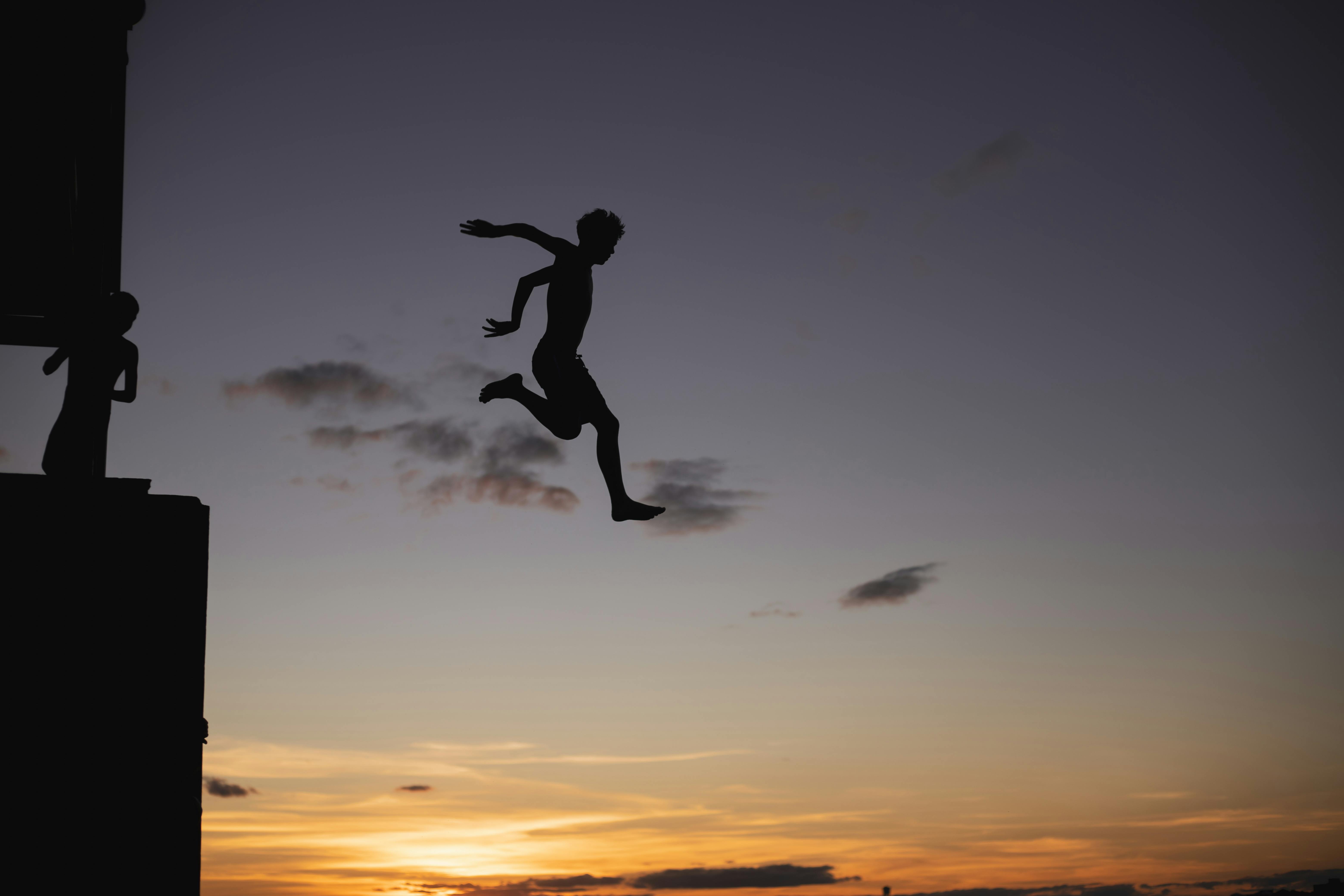 Silhouette Photography Of Jump Shot Of Two Persons · Free Stock Photo