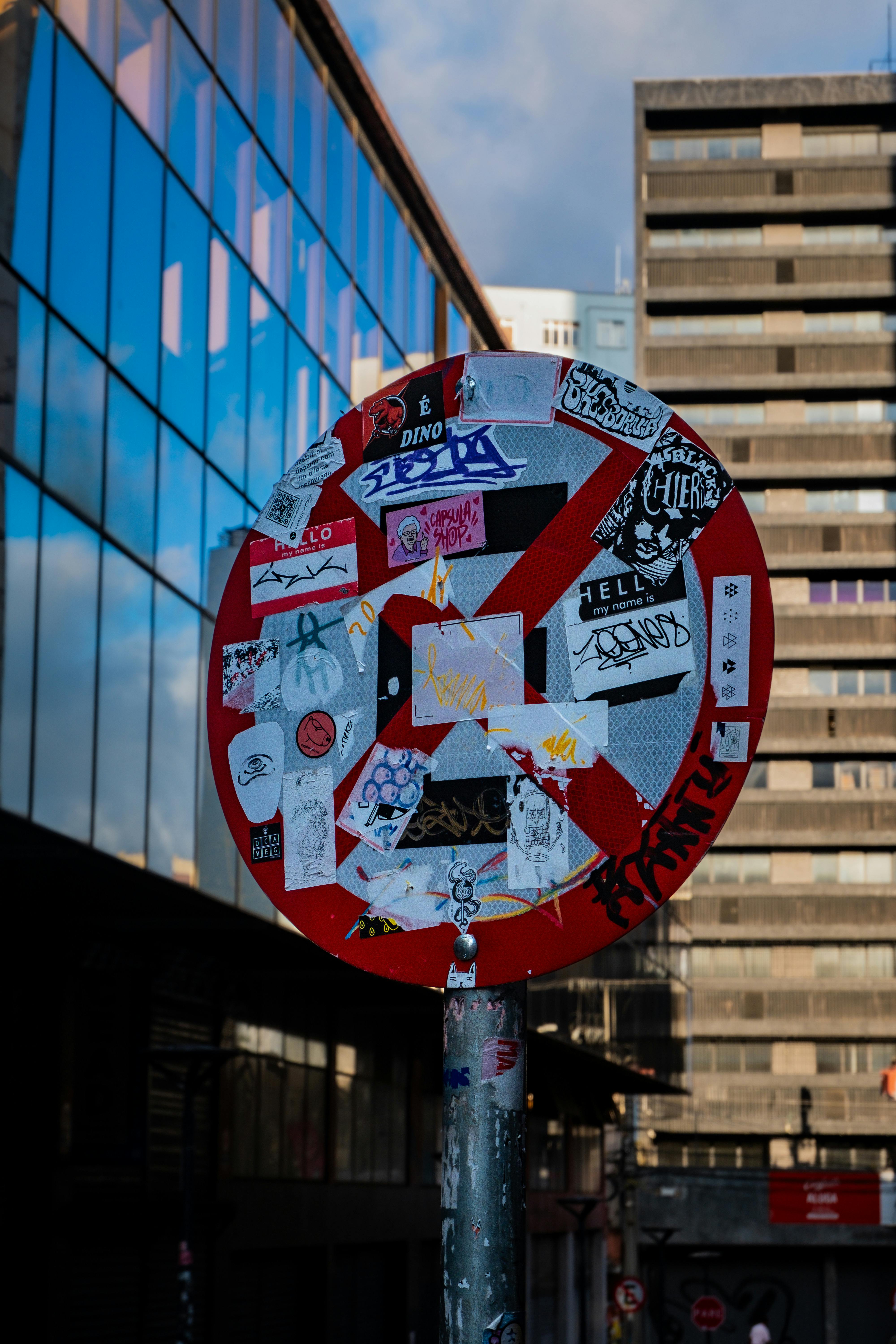 Close-up of a Road Sign Covered with Stickers · Free Stock Photo
