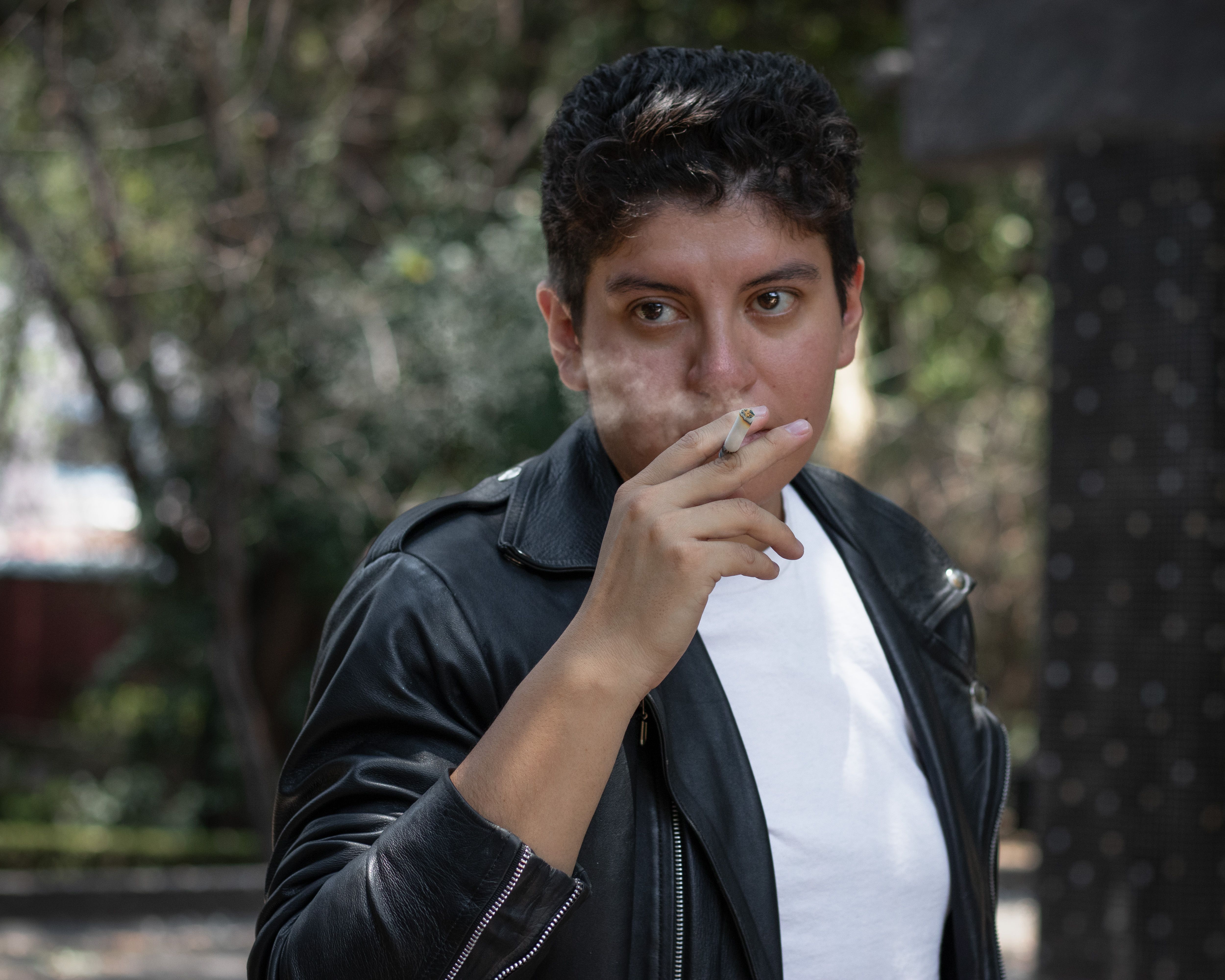 Person in a Leather Jacket Smoking a Cigarette on the Sidewalk · Free ...