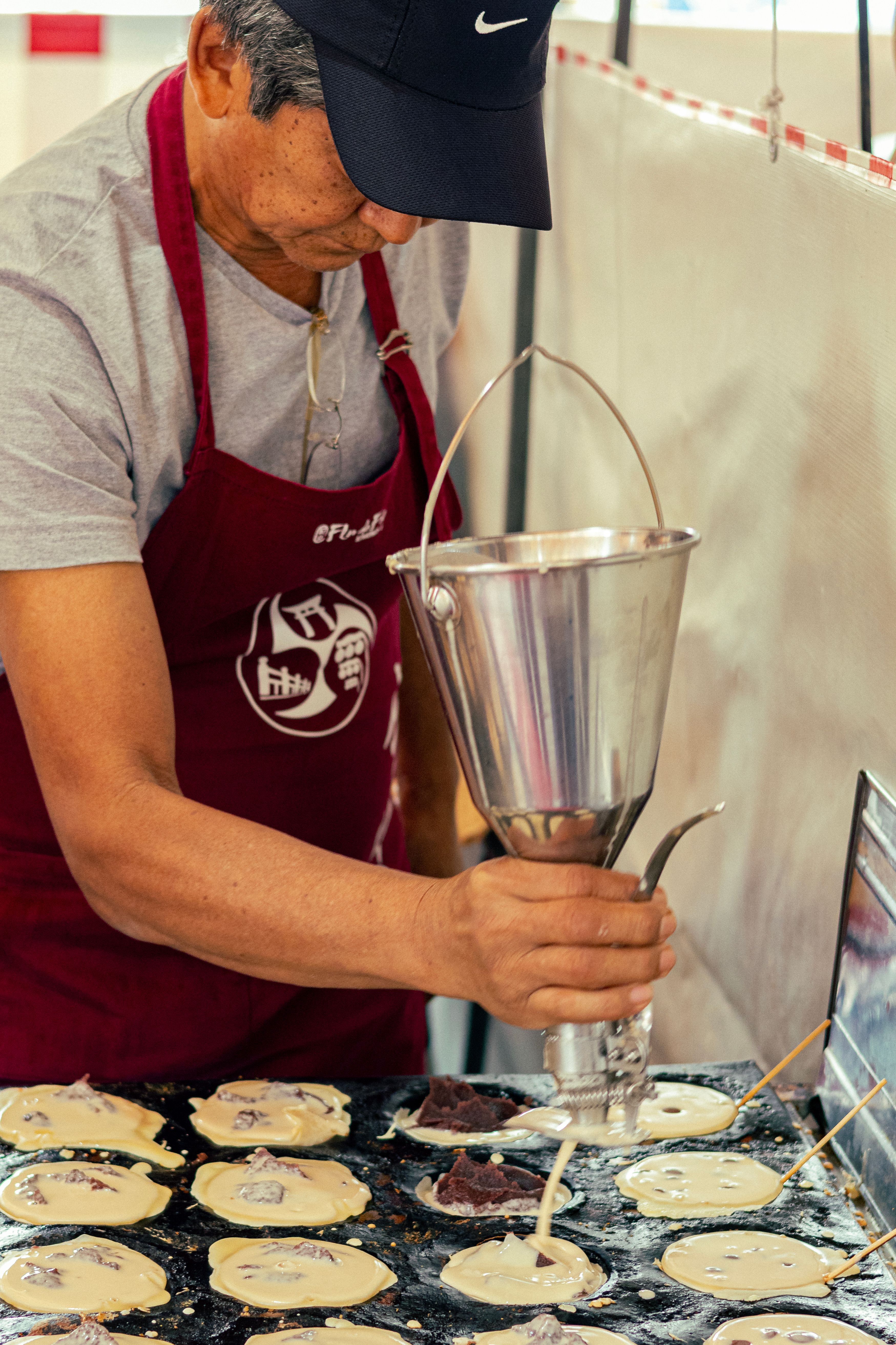 Man Adding Filling Onto Pastry · Free Stock Photo