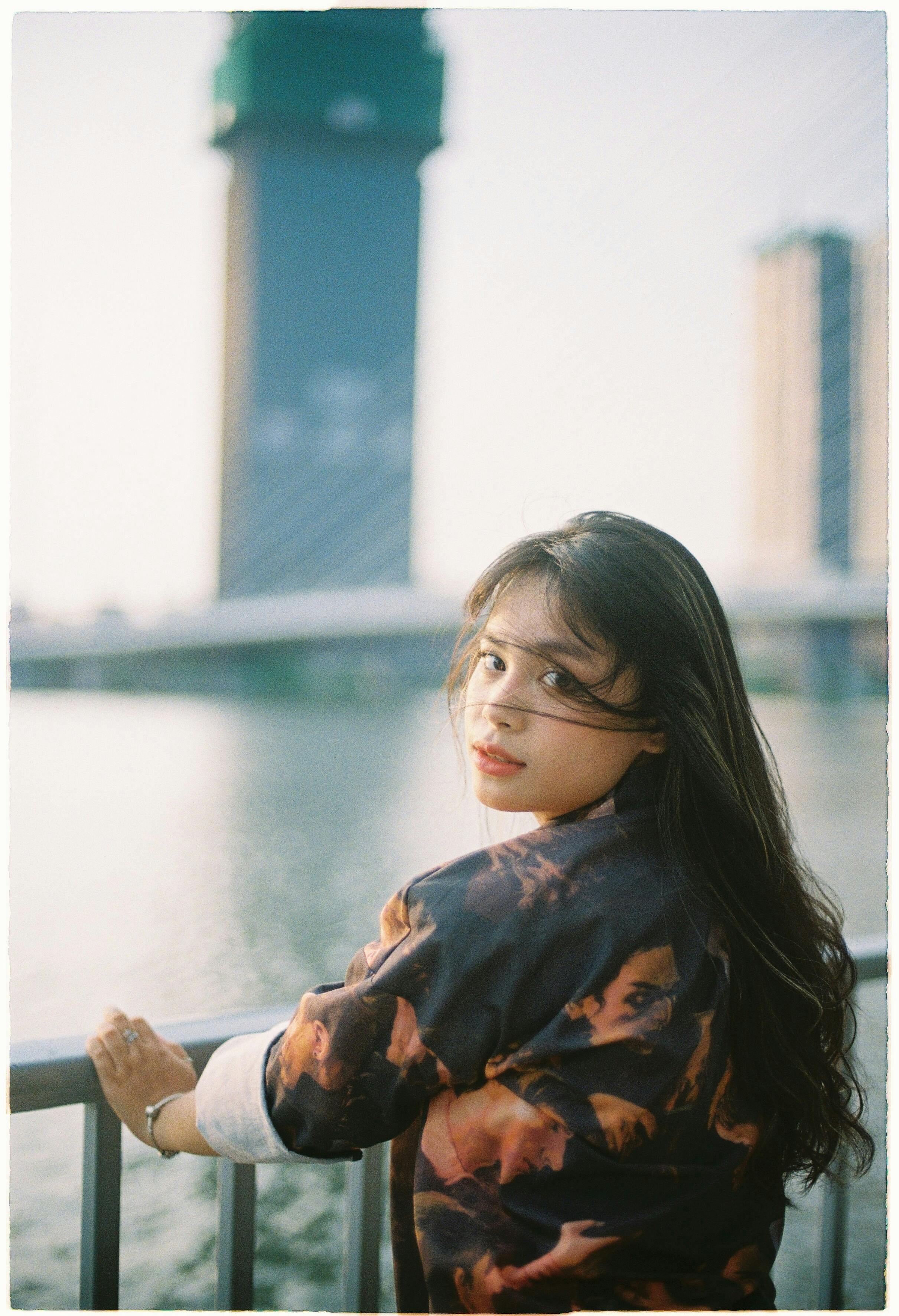 Woman Glancing in Front of an Urban Skyline · Free Stock Photo