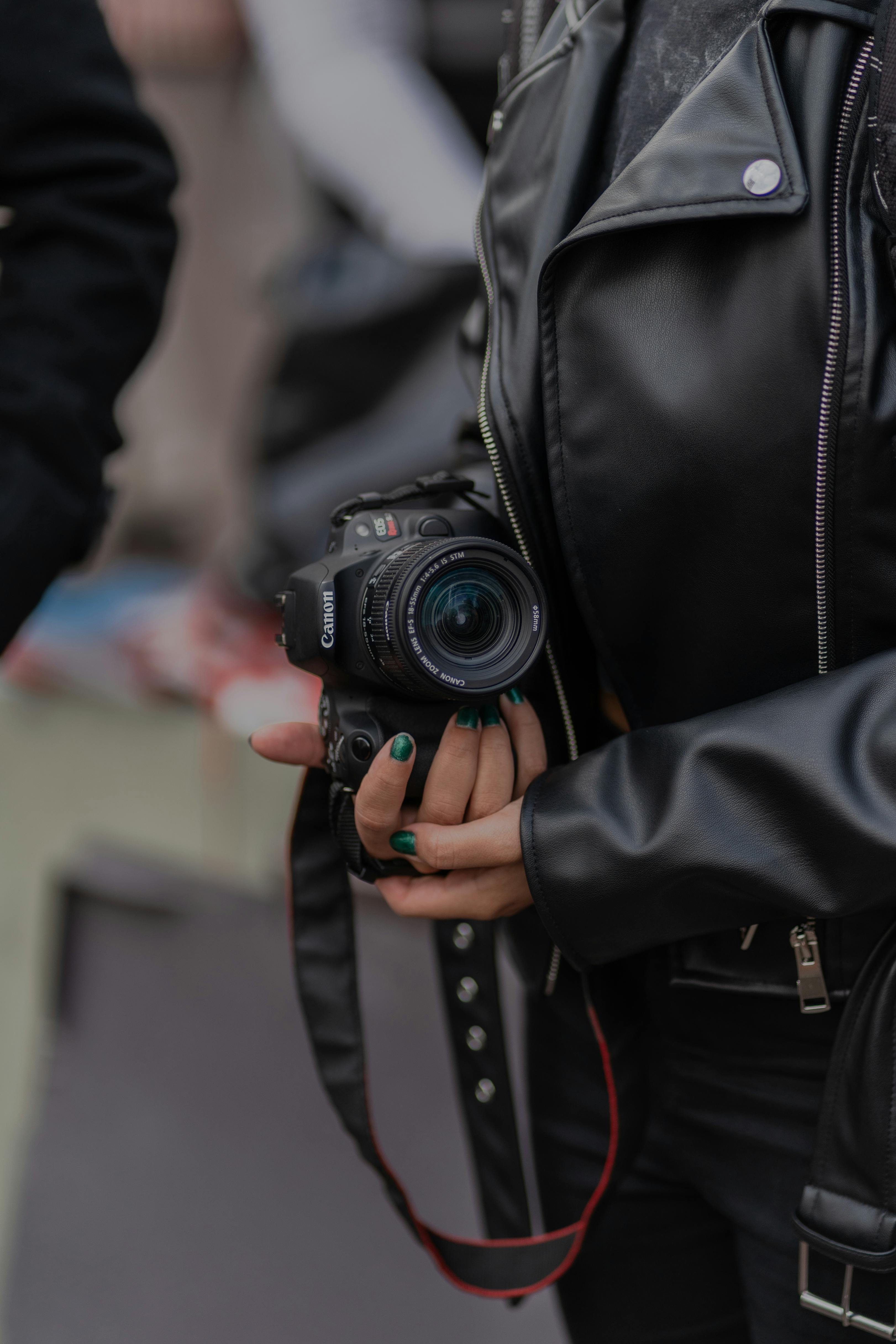 Canon EOS Camera Held by a Photographer in a Leather Jacket · Free ...