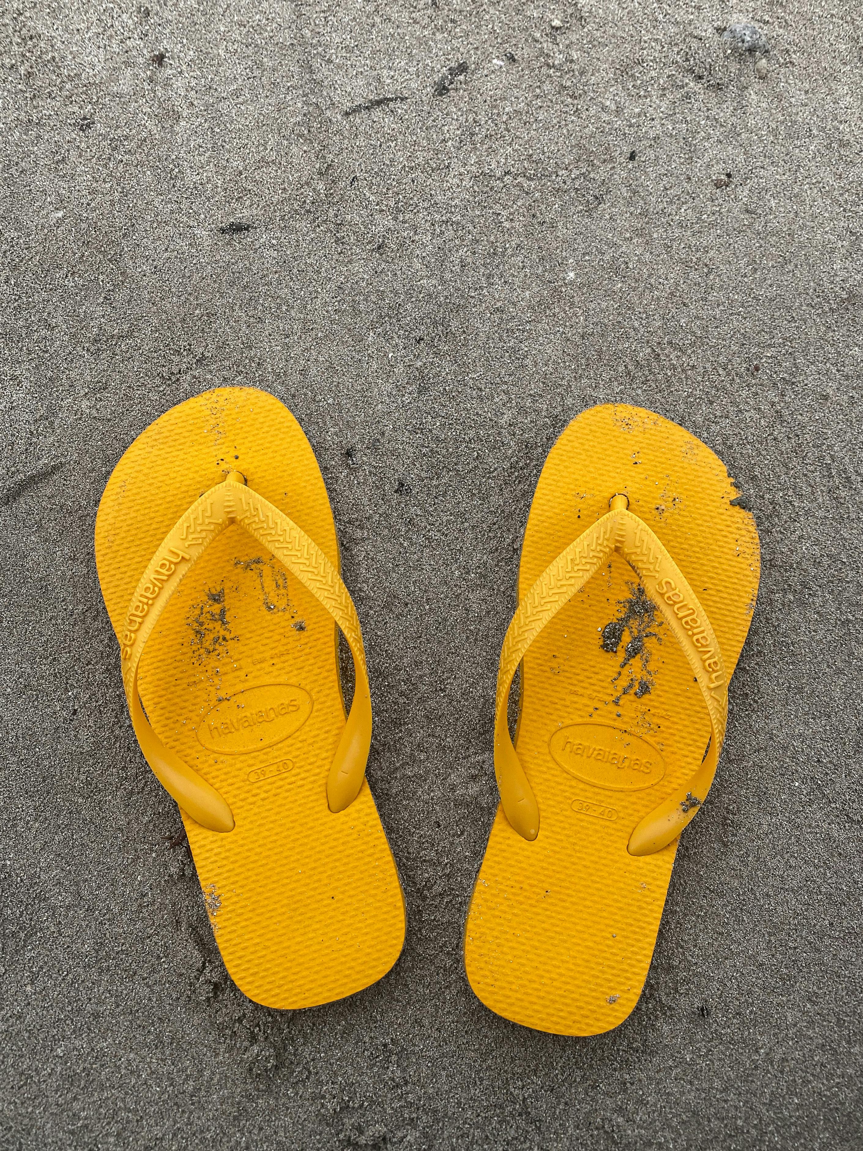 Top View of Yellow Flip Flops on Sand · Free Stock Photo