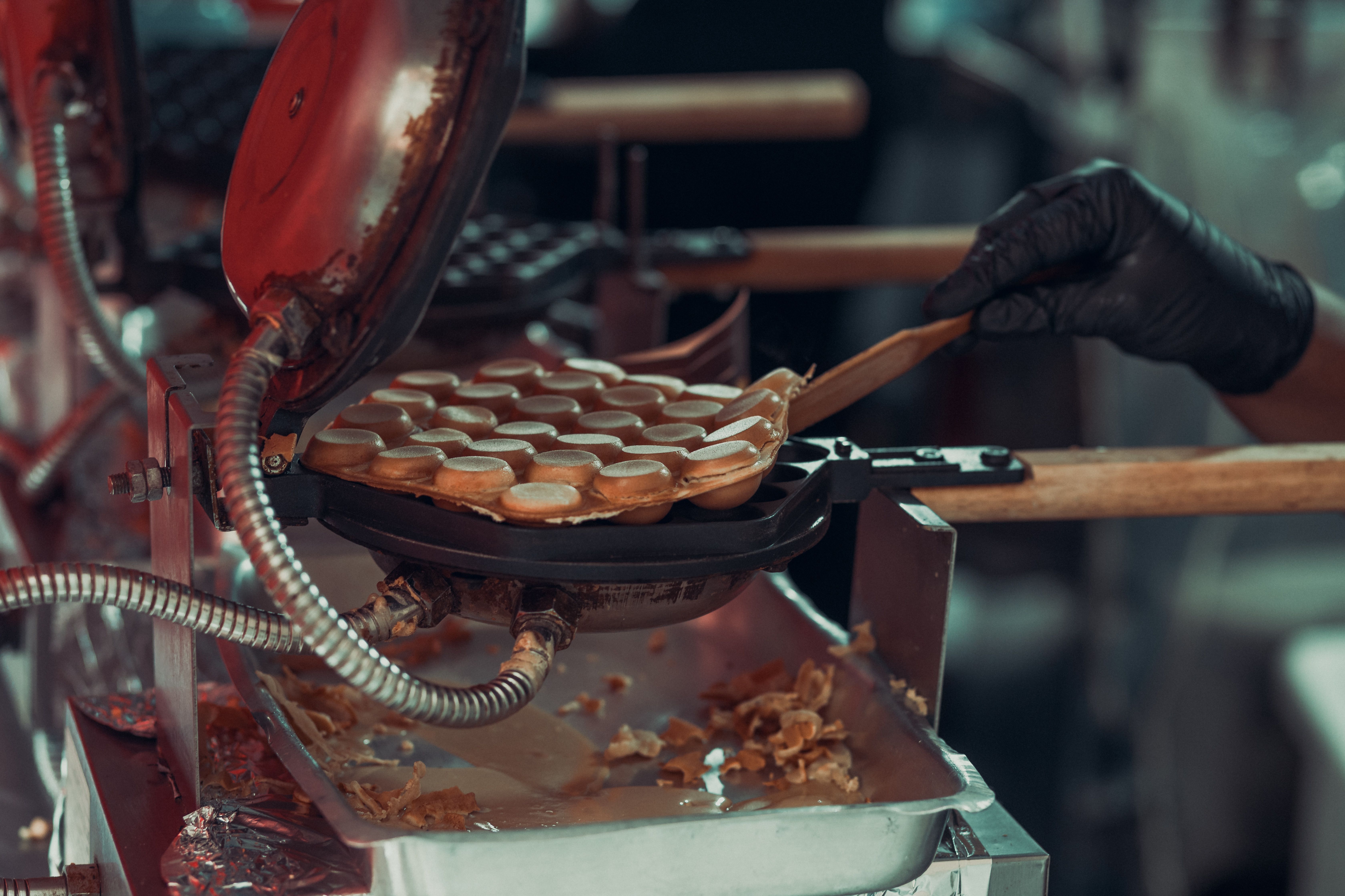 A person in black gloves is making waffles · Free Stock Photo