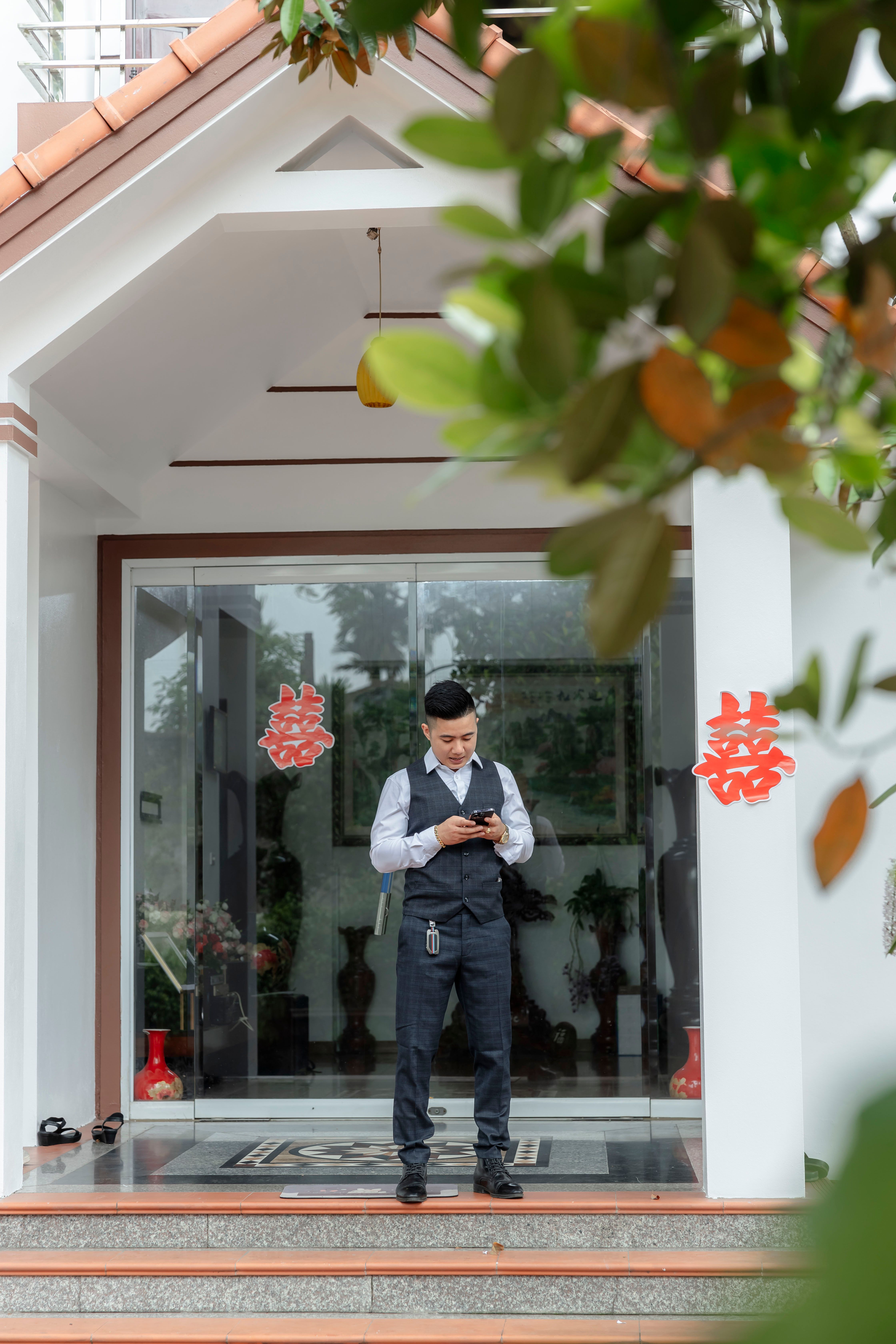 Groom in Front Glass Building · Free Stock Photo