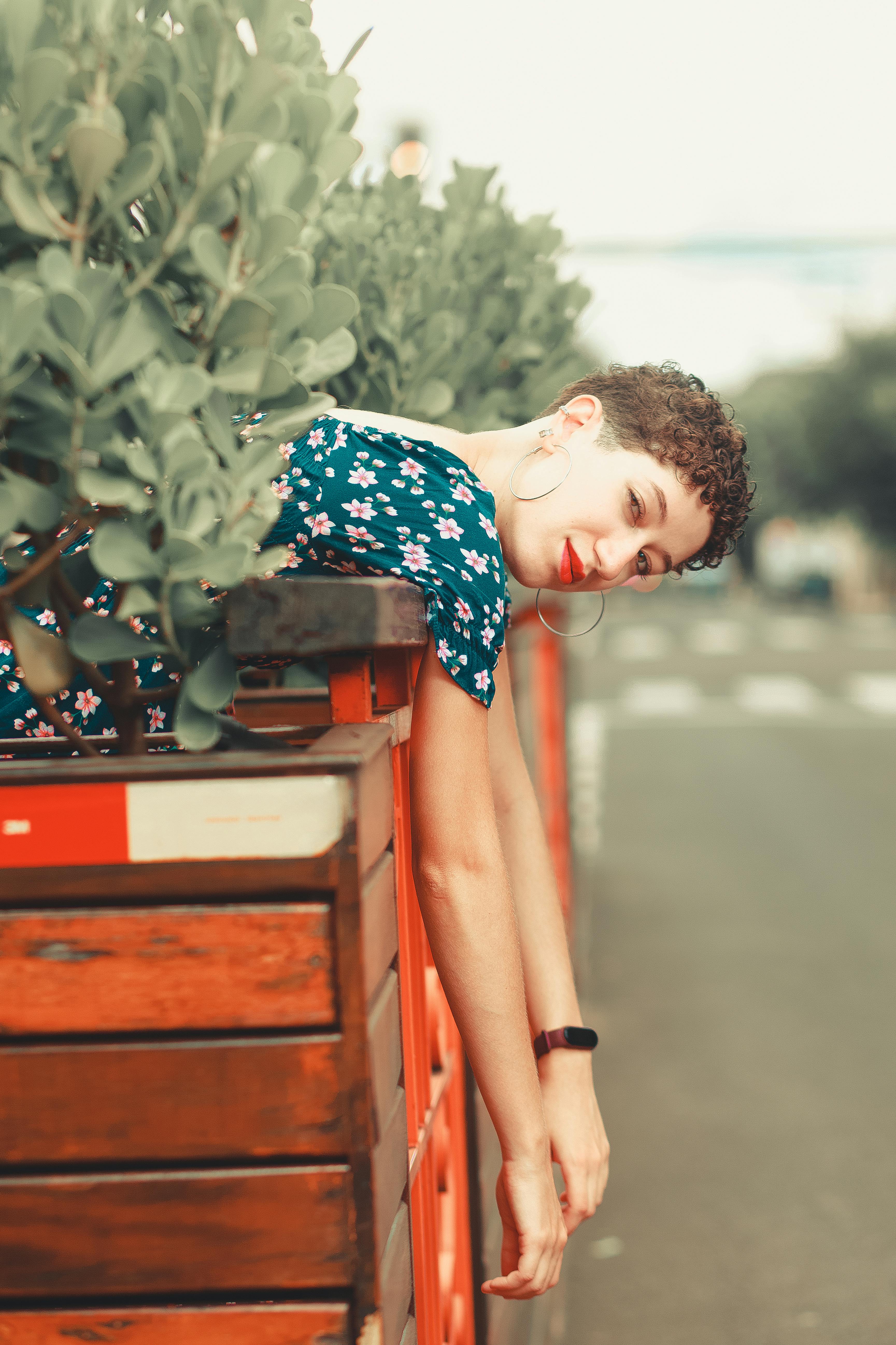 A Woman Hunched over the Patio Balustrade · Free Stock Photo