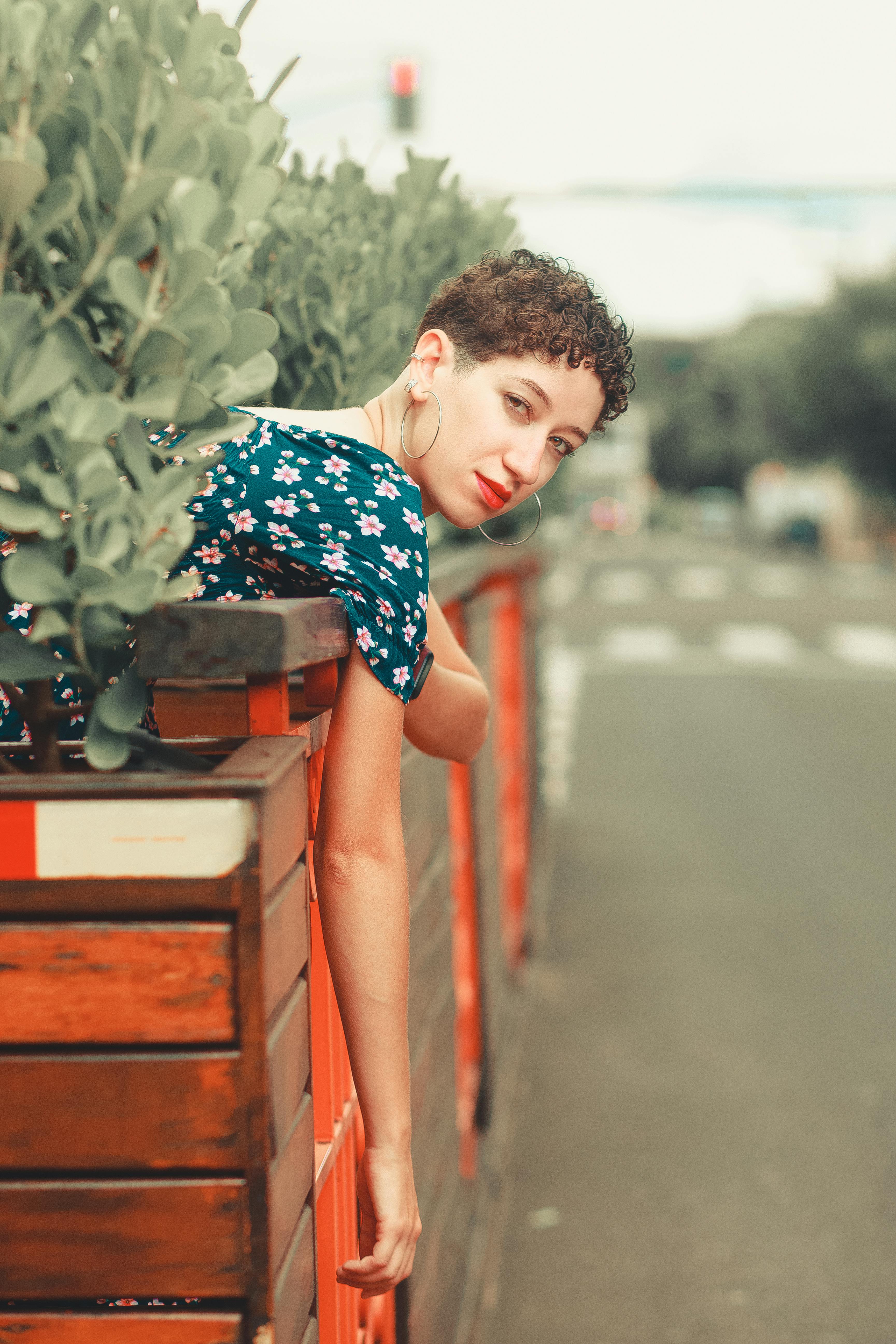 A Woman Hunched over the Patio Balustrade · Free Stock Photo