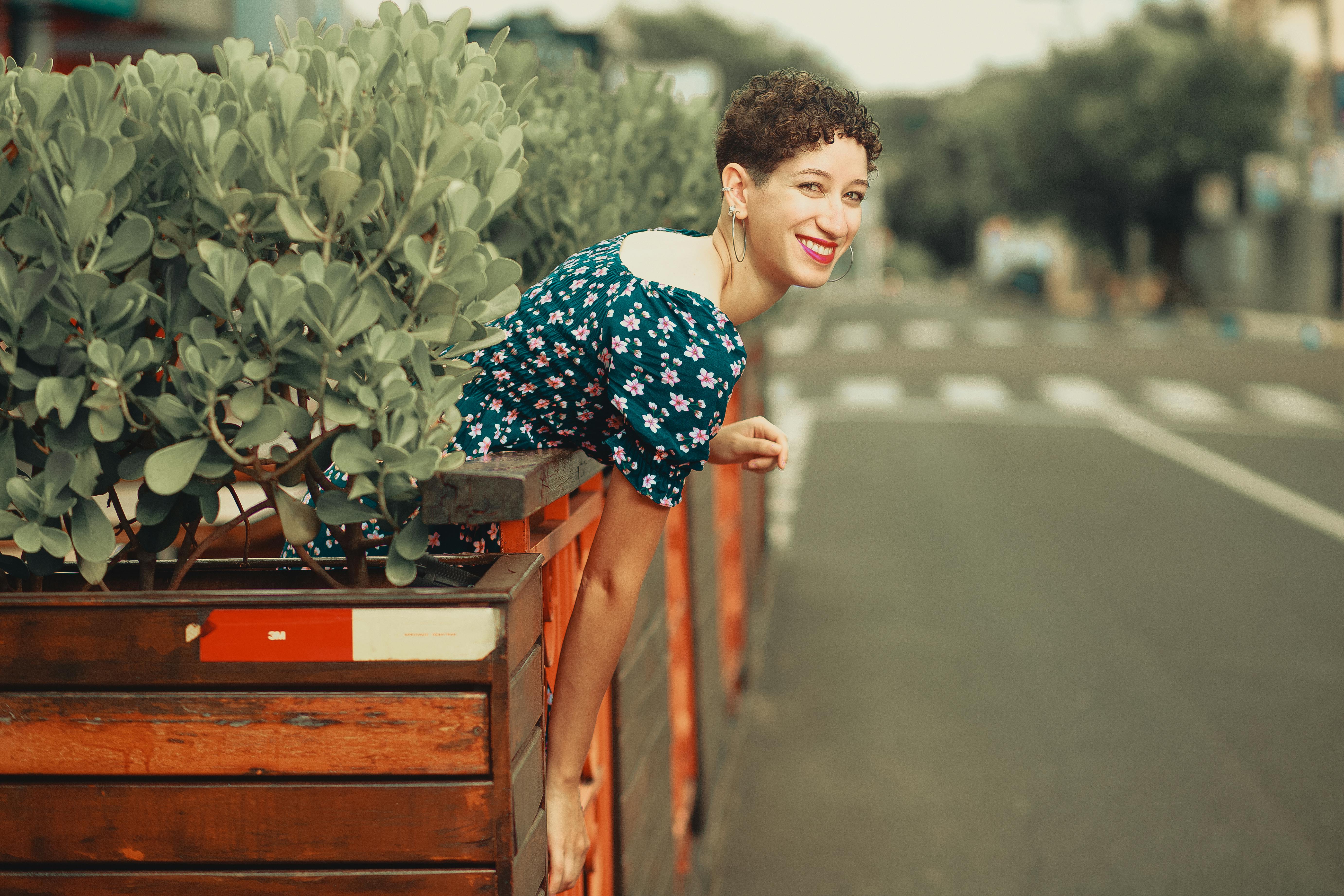 A Woman Hunched over the Patio Balustrade · Free Stock Photo