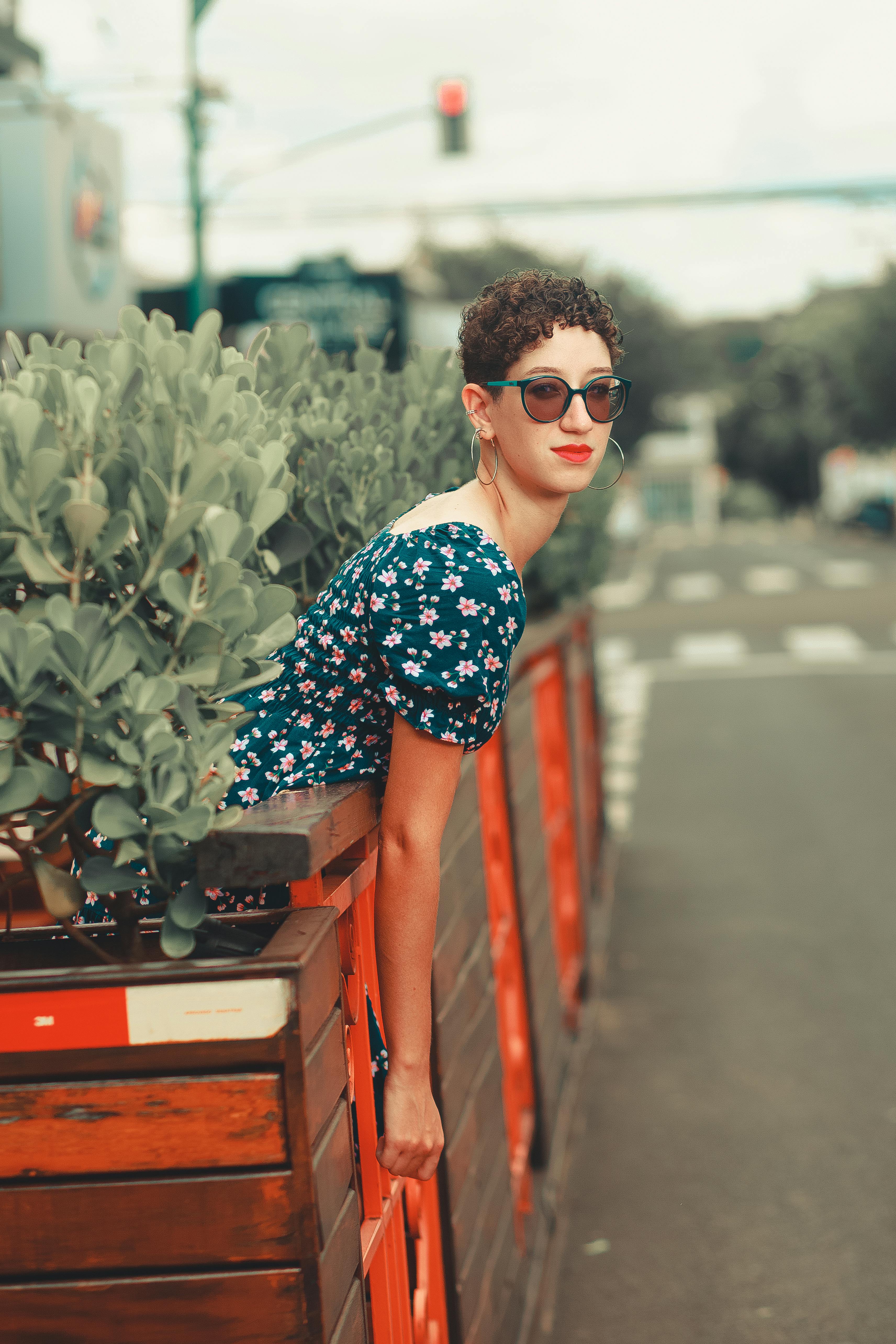 A Woman Hunched over the Patio Balustrade · Free Stock Photo