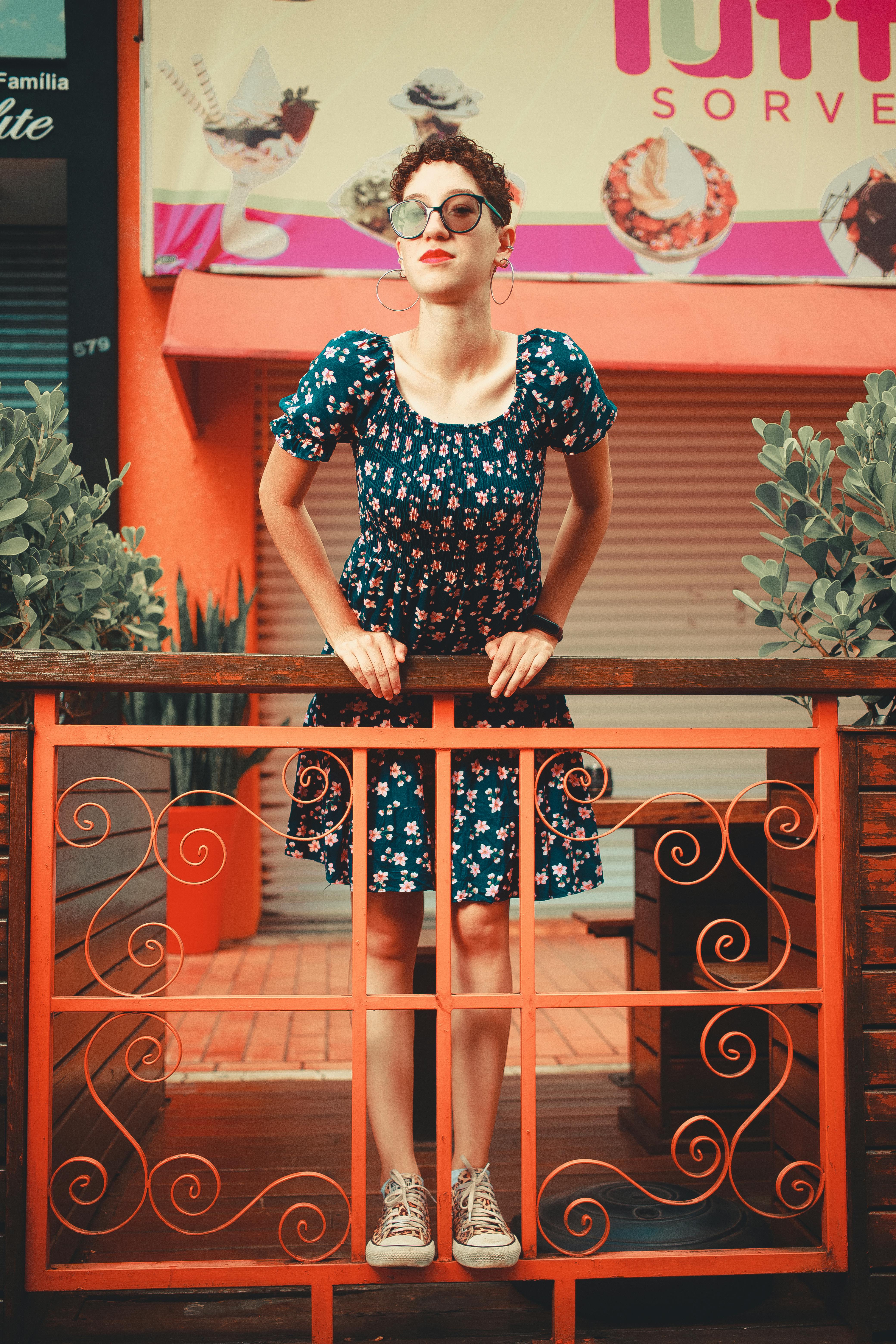 Woman in Sundress Standing behind Railing · Free Stock Photo
