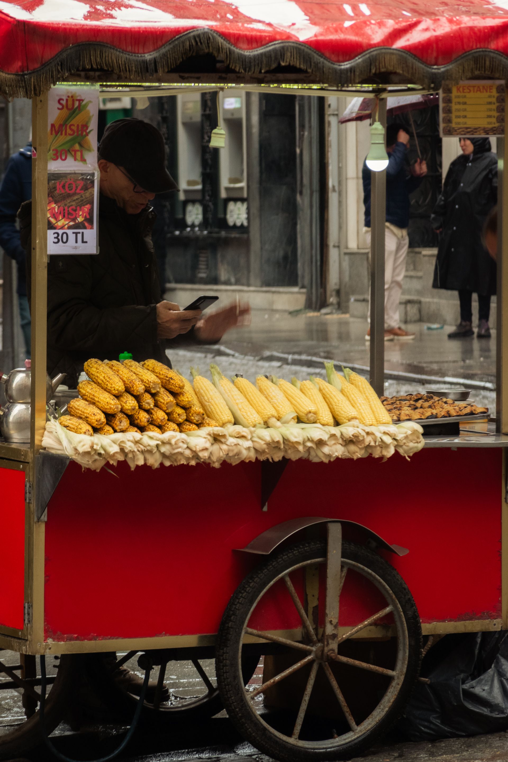 Man Selling Corn from a Food Cart on the Street · Free Stock Photo