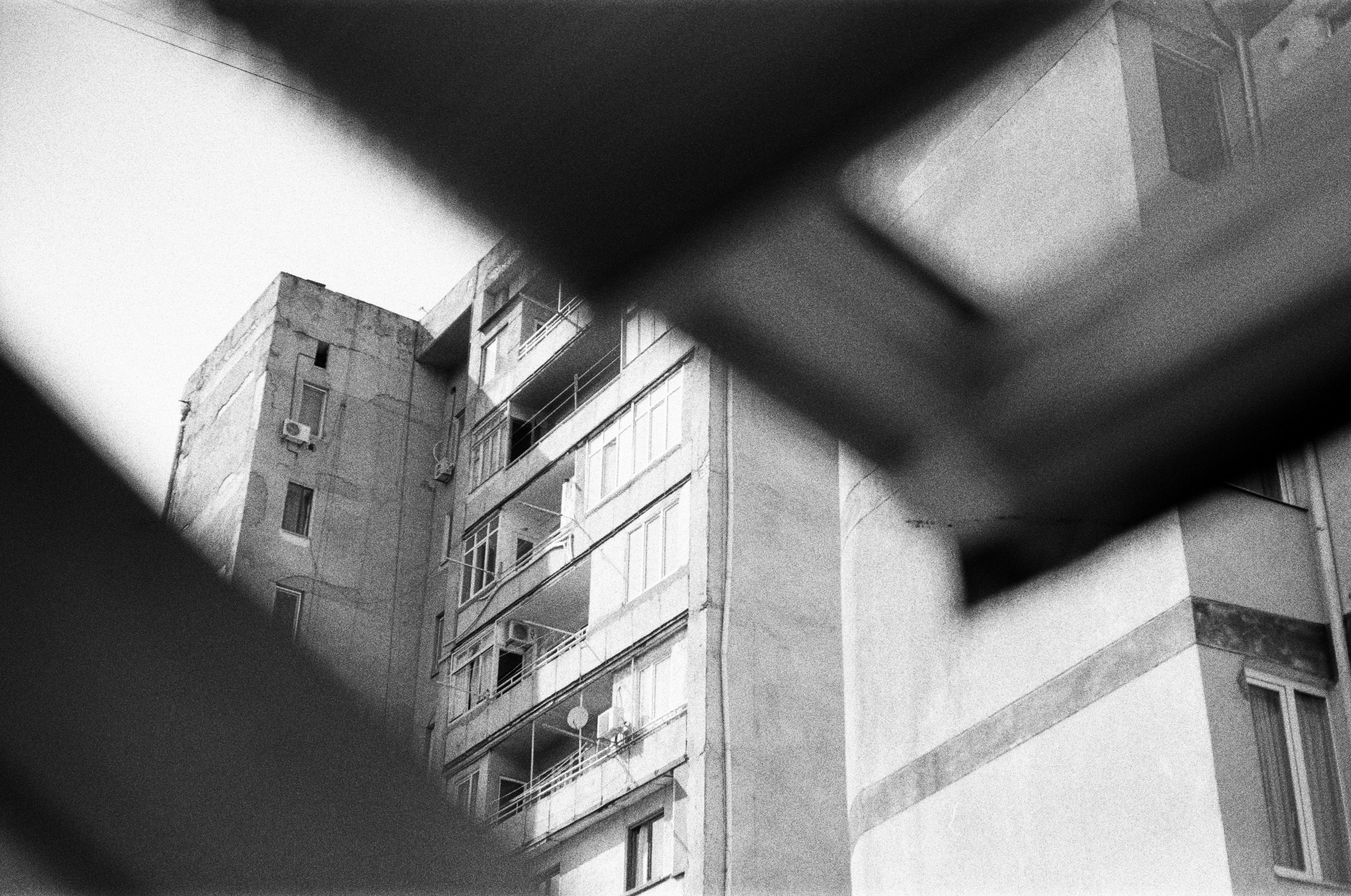 Apartment Building Through a Tilted Roof Window · Free Stock Photo
