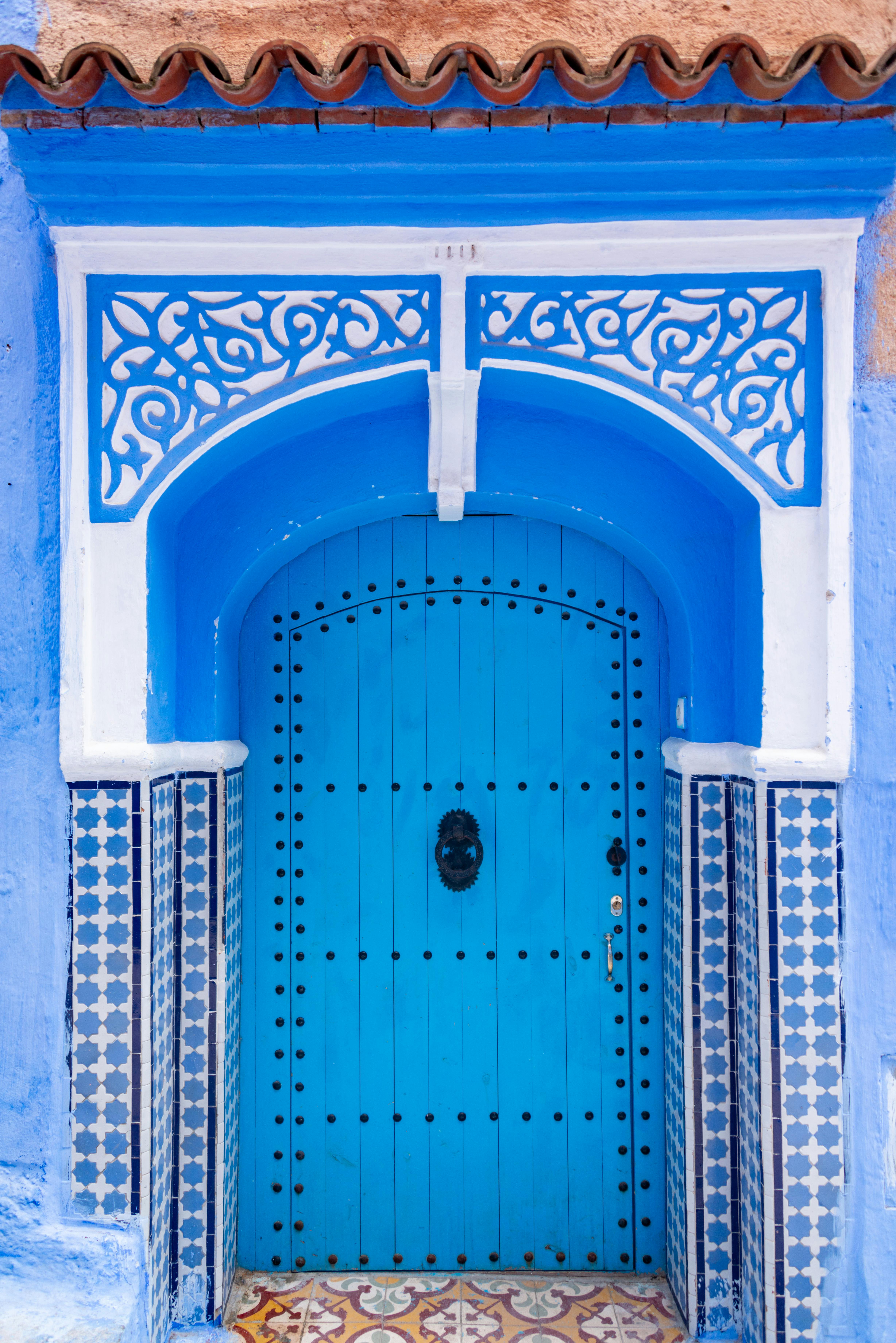 Vibrant Blue Arched Door with Ornate Design · Free Stock Photo