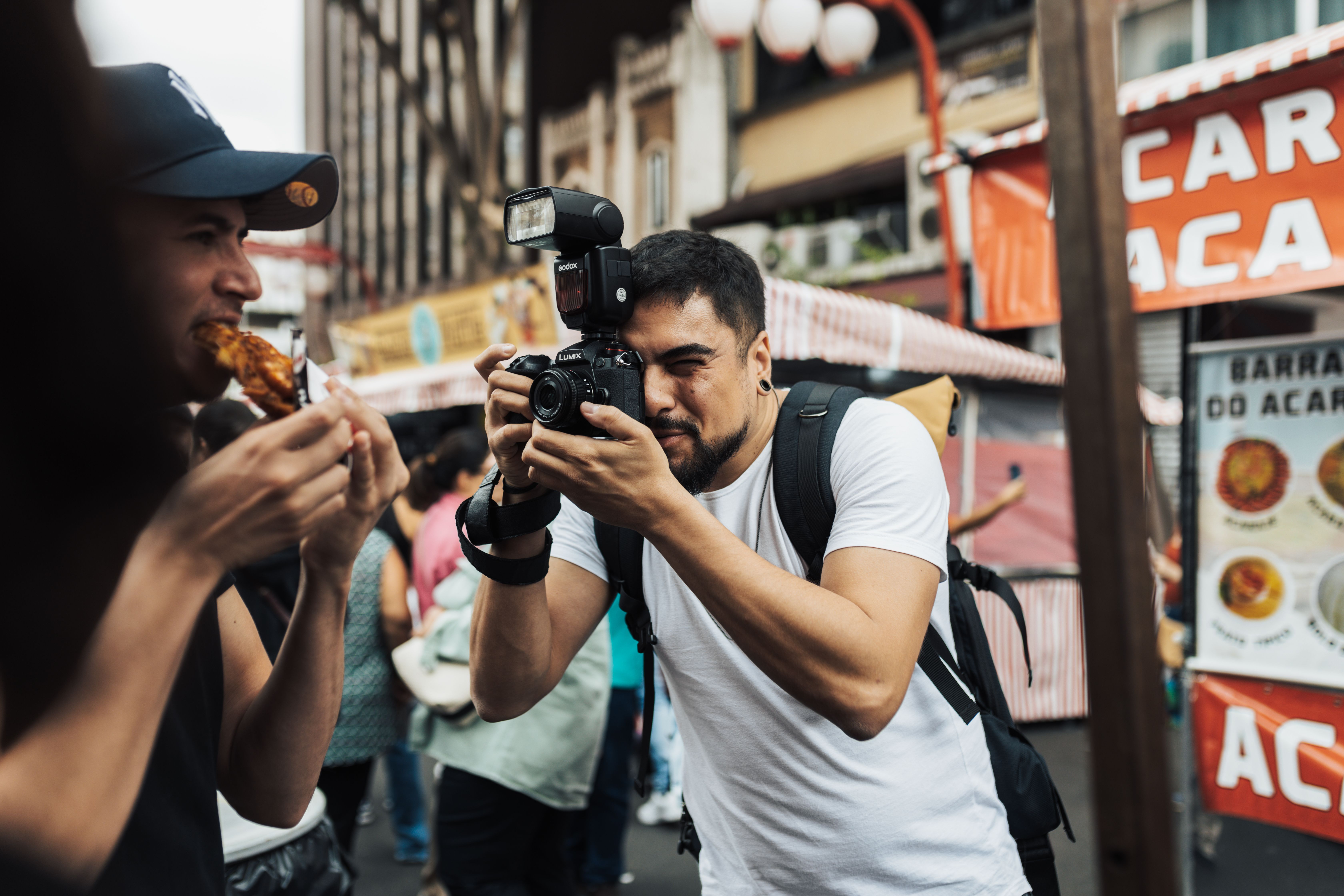 Man Taking Photos on Street Market · Free Stock Photo